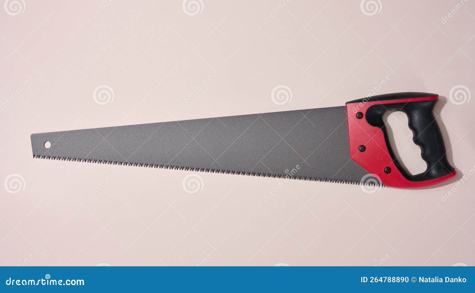 New Hand Saw with a Rubber Red Handle on a Beige Background Stock Photo ...