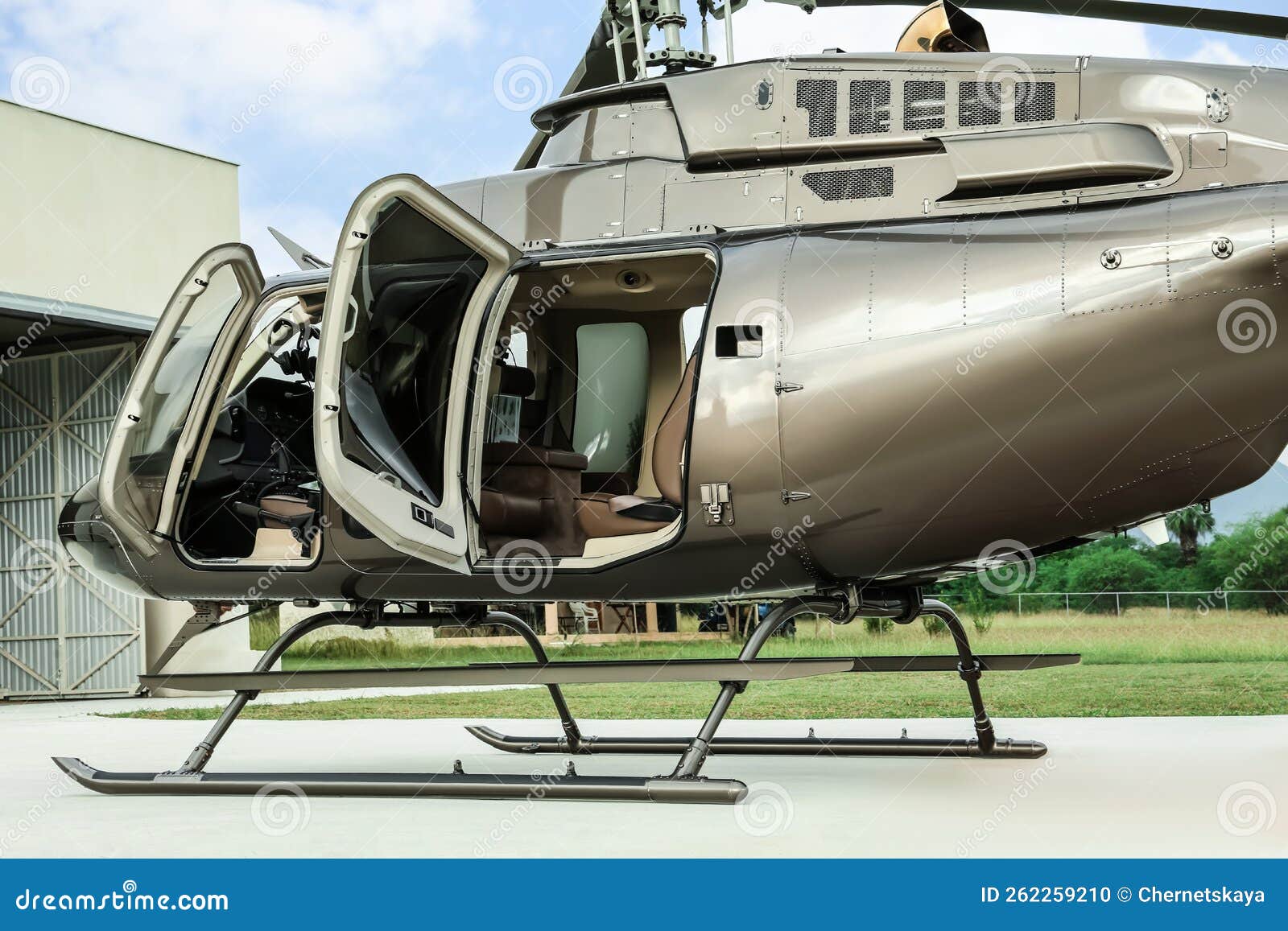 New Helicopter with Open Cabin Doors on Helipad Outdoors Stock Photo ...