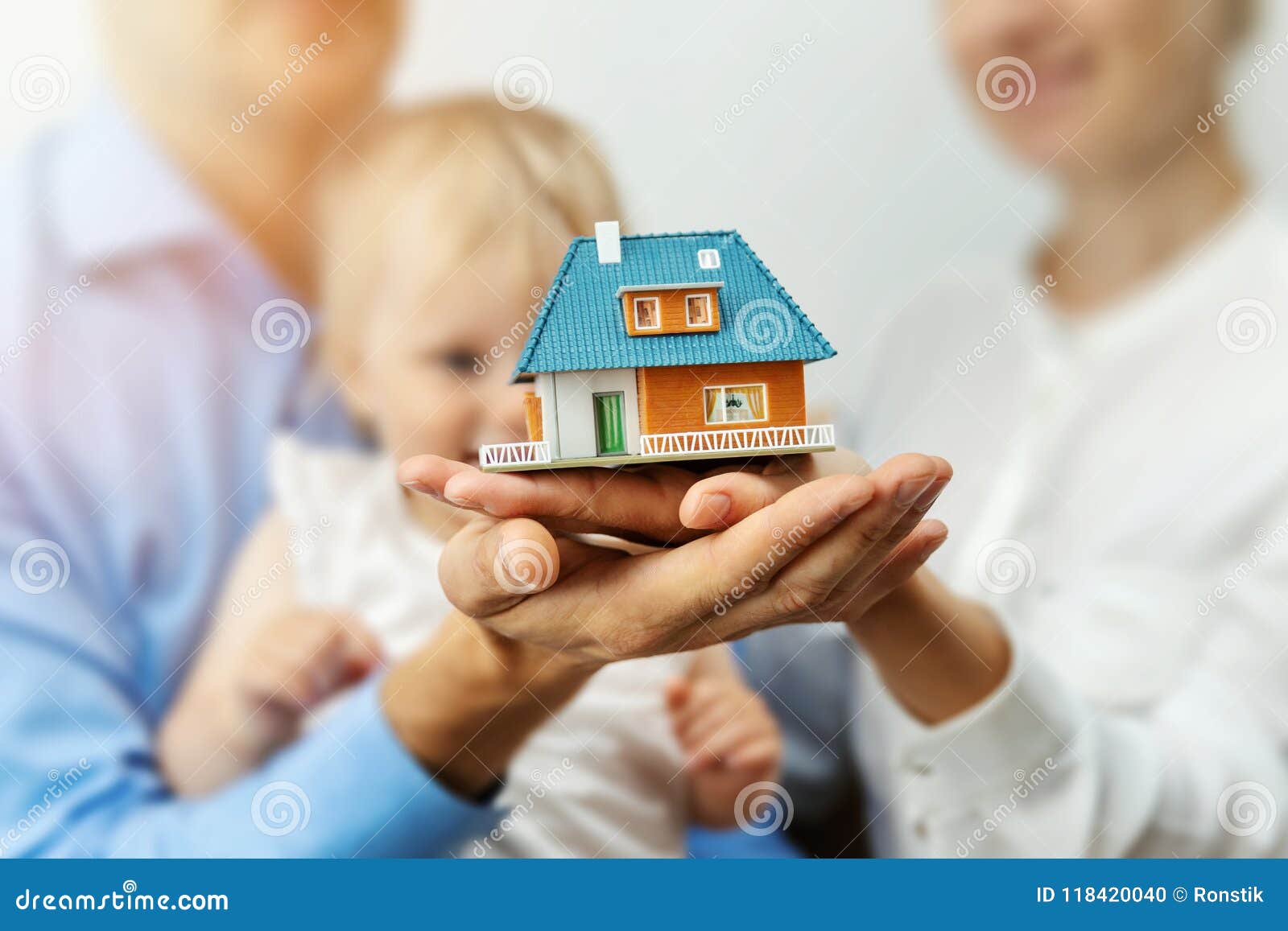 New Home Concept - Young Family with Dream House Scale Model Stock ... New Home Concept - Young Family with Dream House Scale Model Stock ...