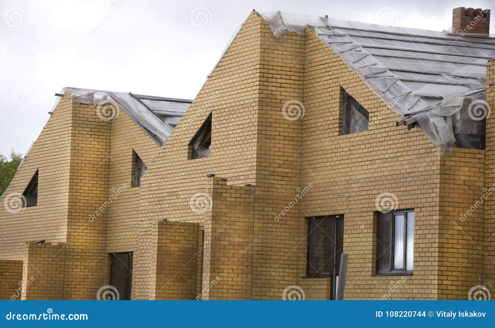 New Homes Under Construction of Yellow Brick . Stock Photo - Image of ...