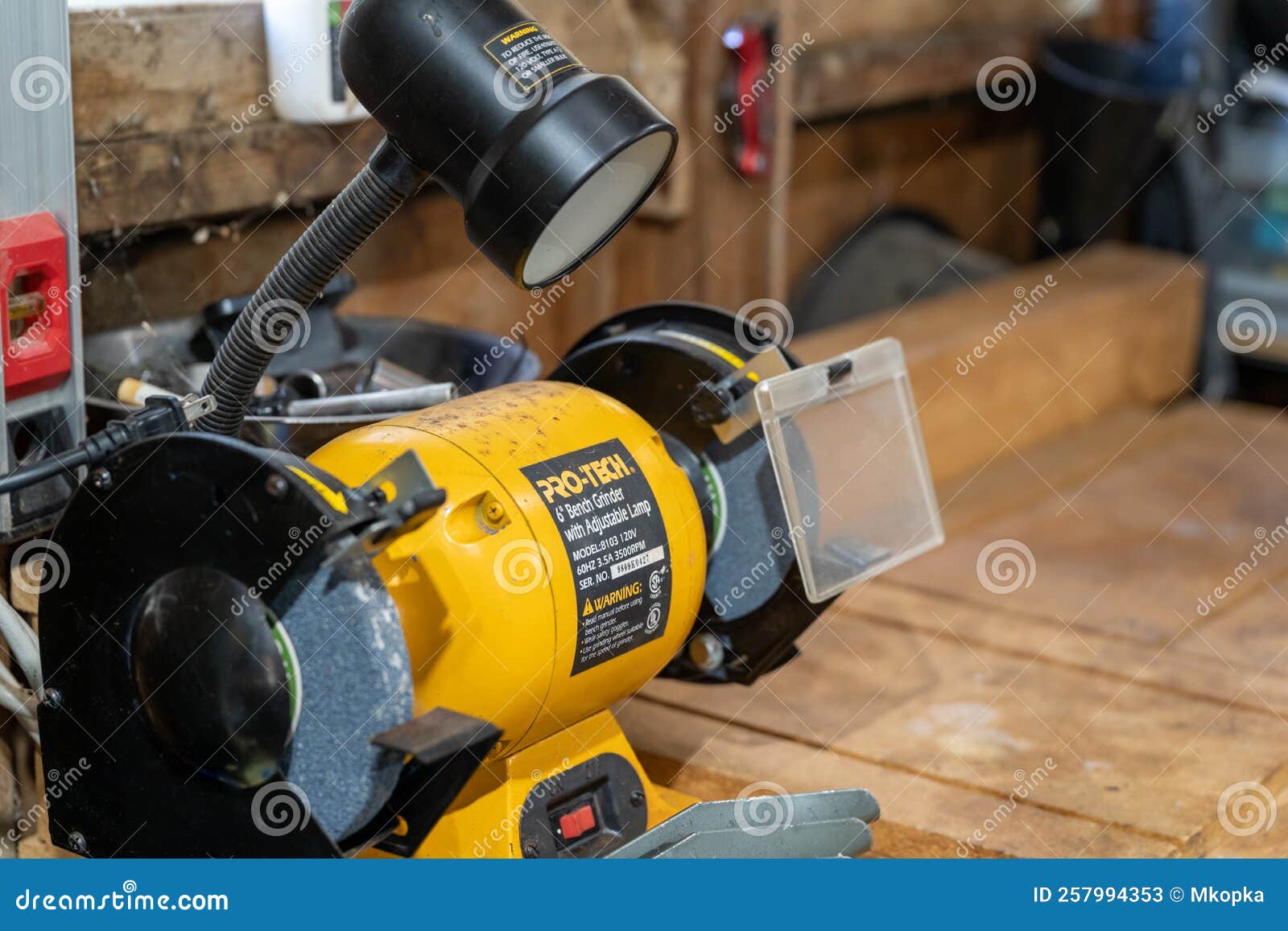 A Pro-Tech Bench Grinder on a Workbench in a Garage Editorial Stock ...