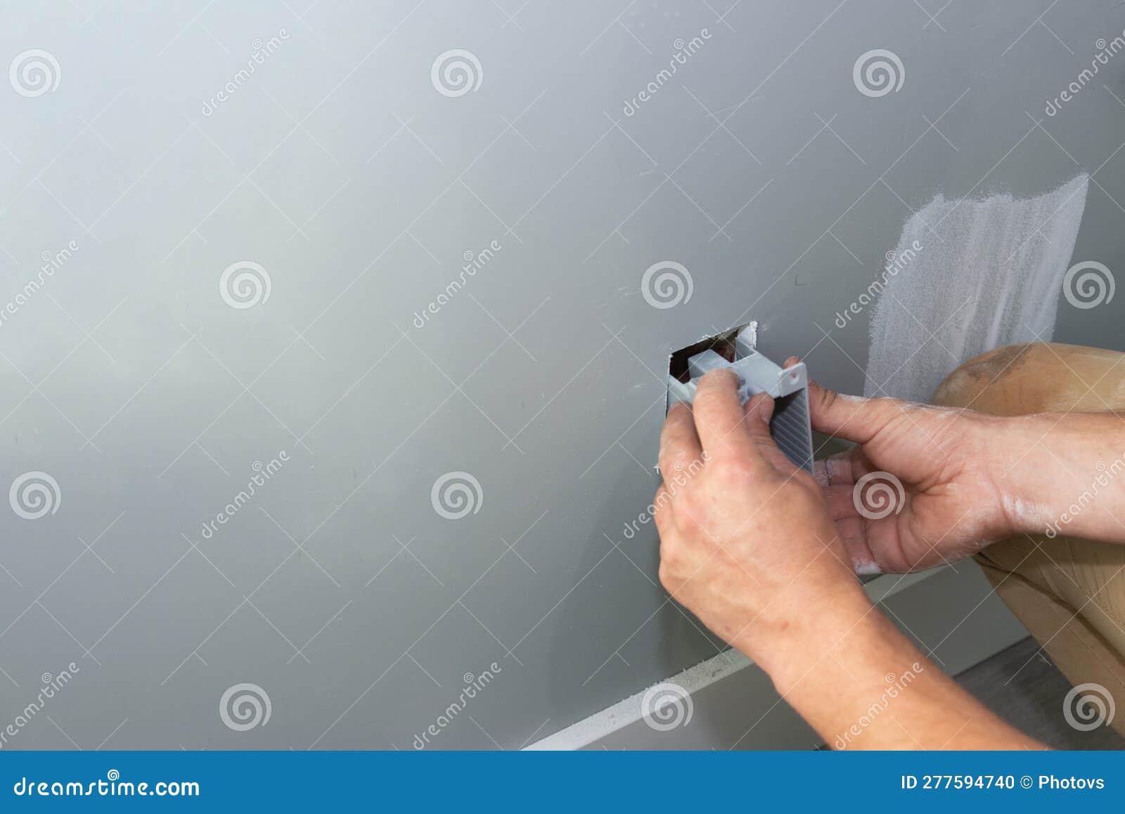In a New House Construction Site, an Electrician Installs a New Current ...