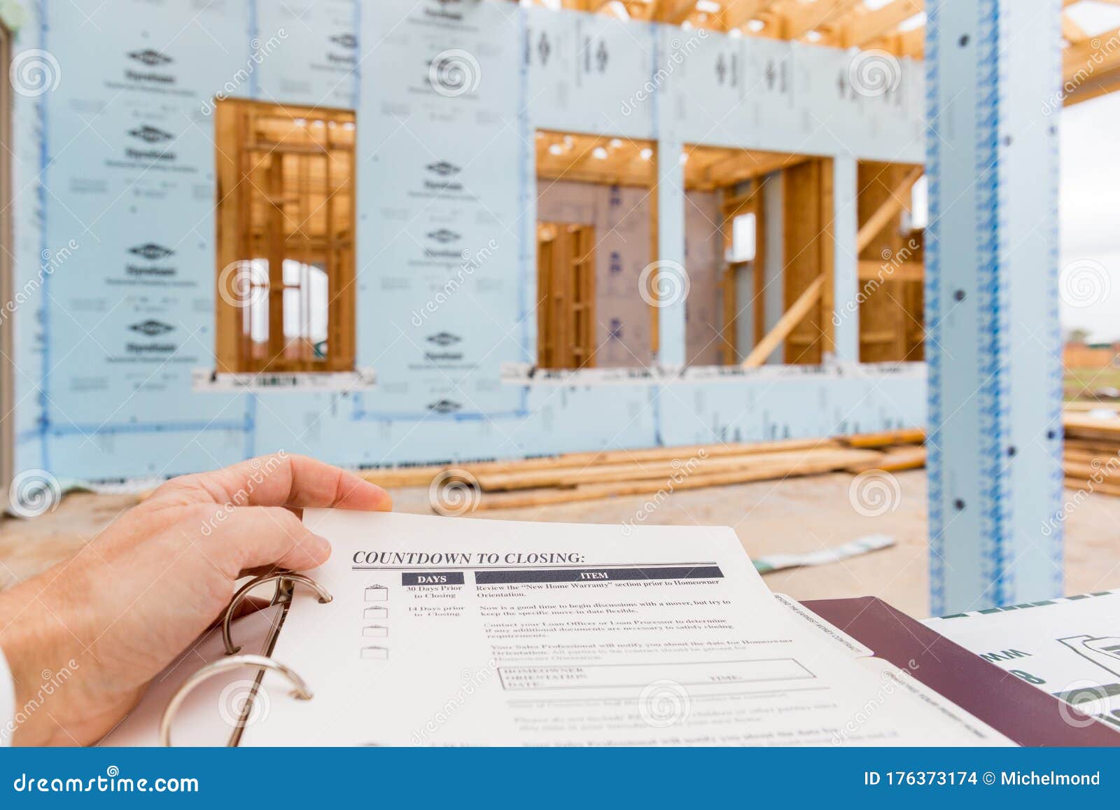 A New House Under Construction and New Home Closing Documents Folder ...