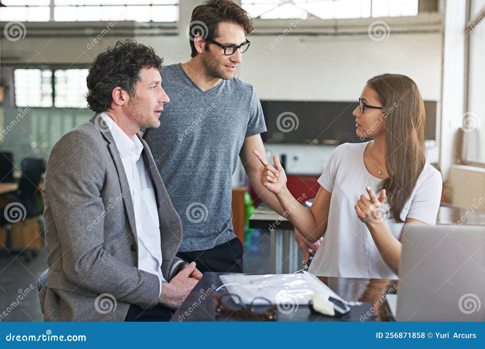 New Ideas Need a Dynamic Team. Colleagues Working Together on a Laptop ...