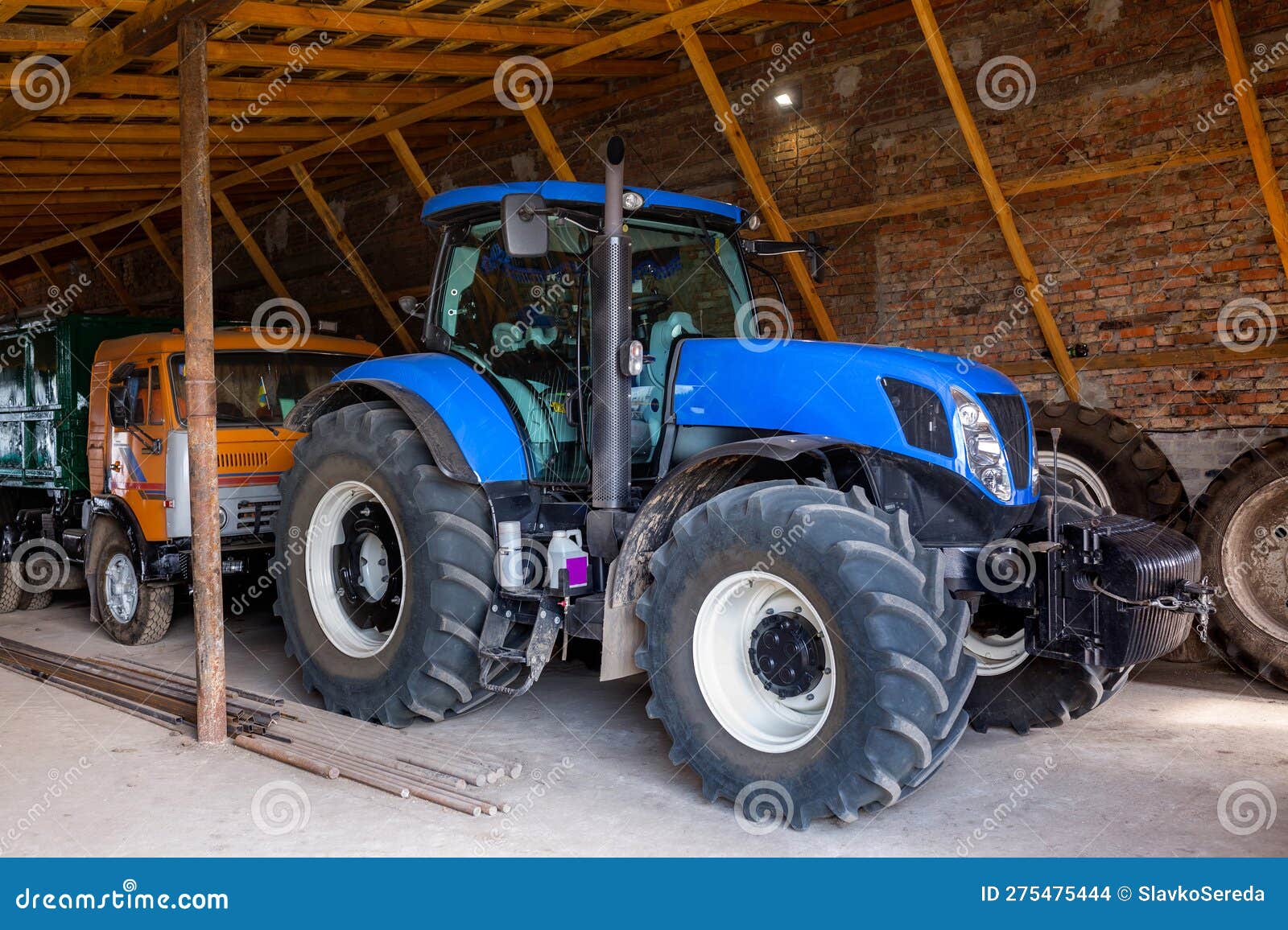 A New Modern Blue Tractor is Parked in a Farm Hangar Stock Photo ...