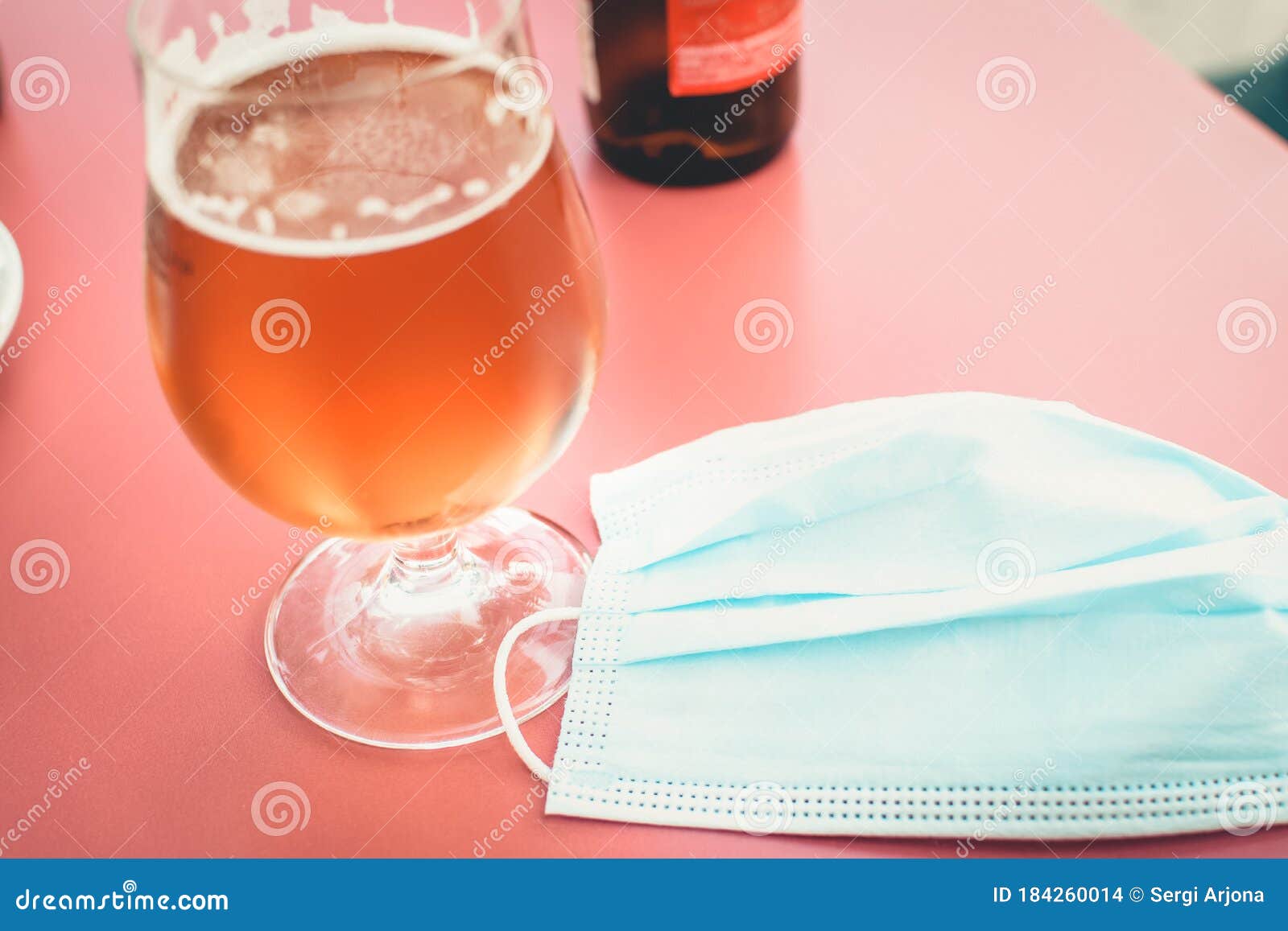 Beer Glass with a Face Mask on the Table Stock Photo - Image of ...