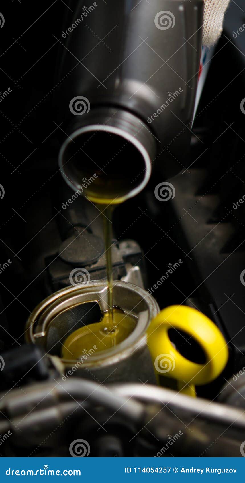 New Oil Flows from the Bottle into the Engine of the Car Stock Image ...