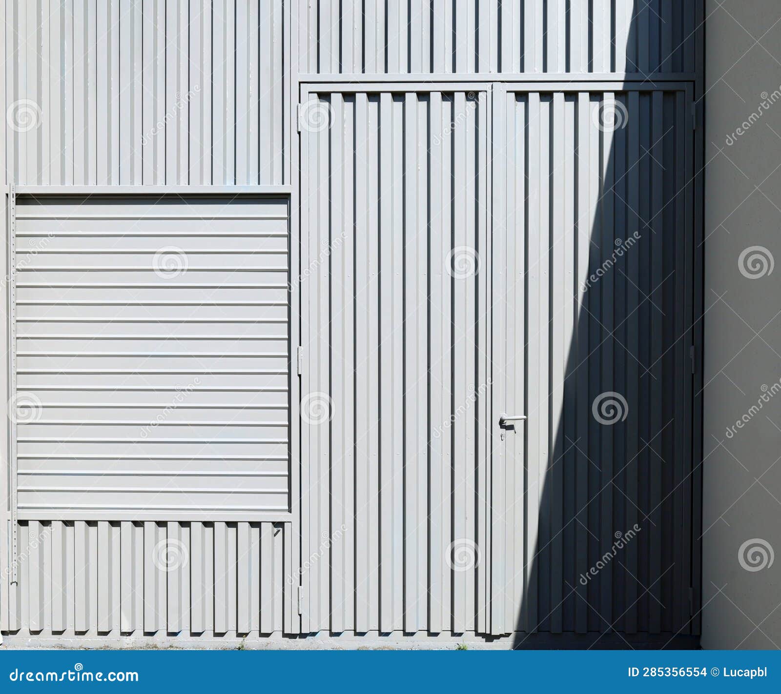 New Prefabricated Metal Door and Shutter on Corrugated Metal Wall ...