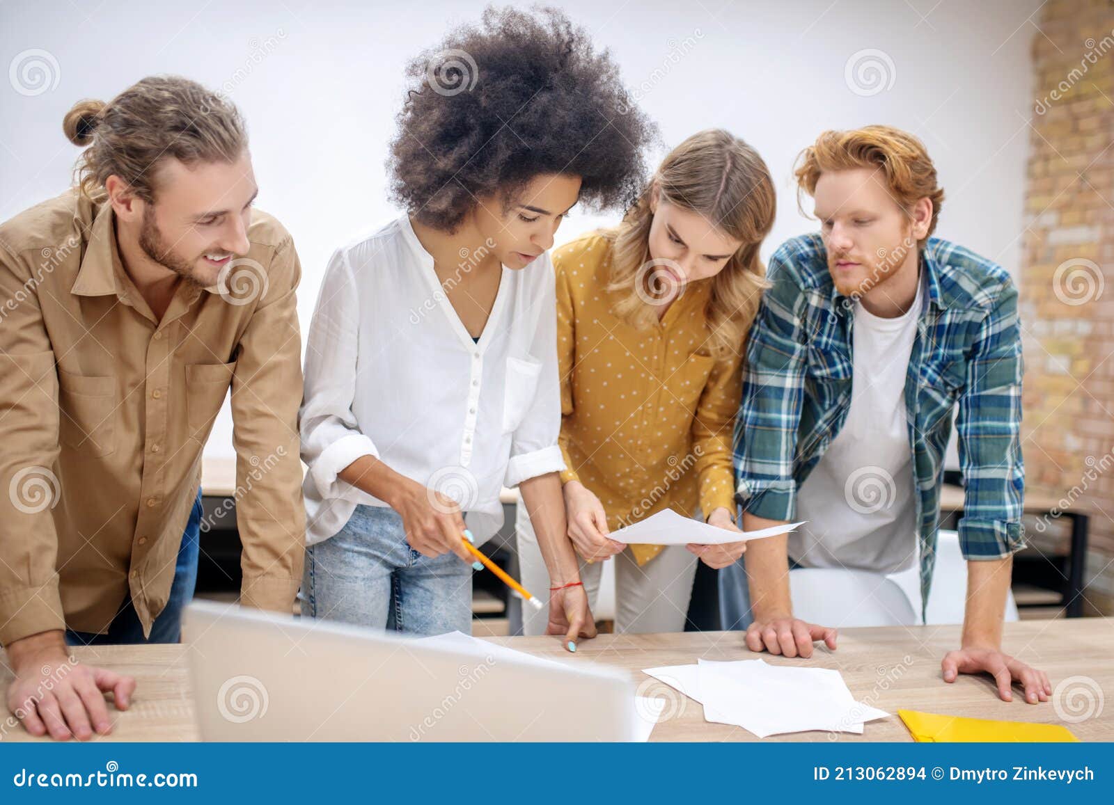 Group of Young Professionals Working on the Project Together and ...