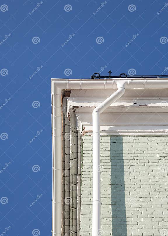 New Rain Gutter on a Brick Wall Against Blue Sky. Stock Photo - Image ...
