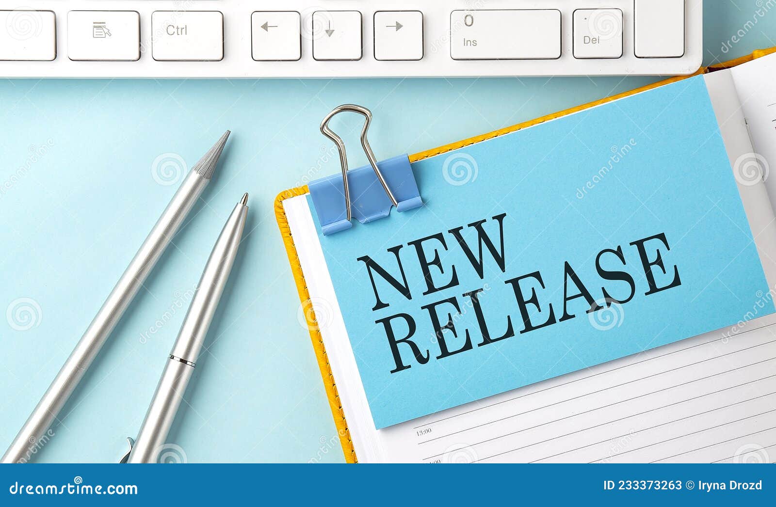 NEW RELEASE Text on Sticker on the Blue Background with Pen and ...