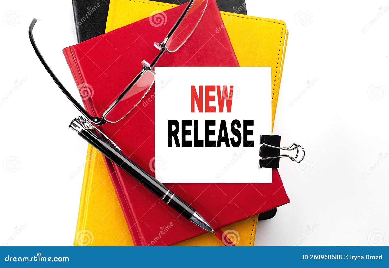 NEW RELEASE Text Written on a Sticky on Colorful Notebooks Stock Photo ...