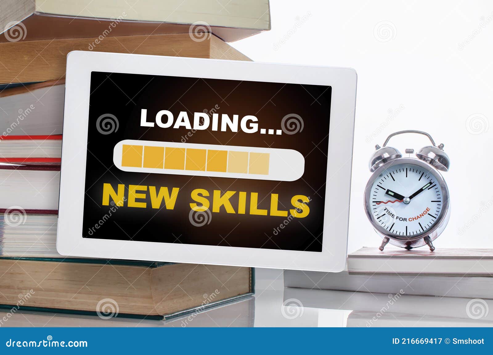 New Skills Loading on Digital Computer Tablet with Stack of Textbook ...
