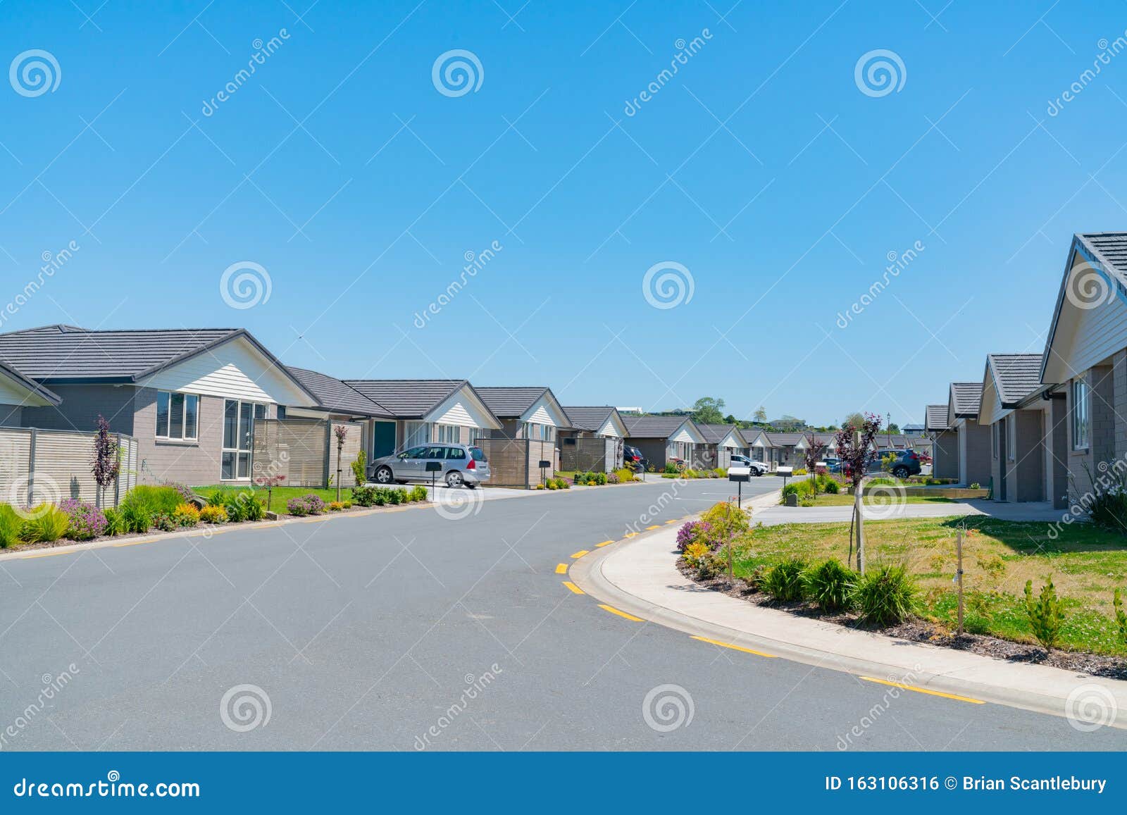 New Subdivision Street with Uniform Homes Stock Photo - Image of line ...