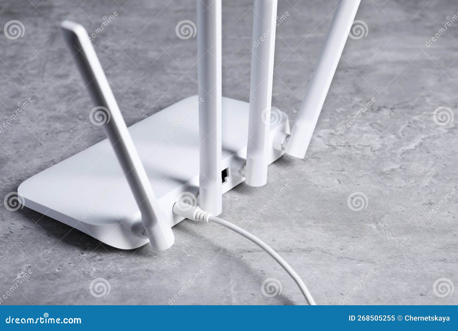 New White Wi-Fi Router on Grey Textured Table, Closeup Stock Image ...