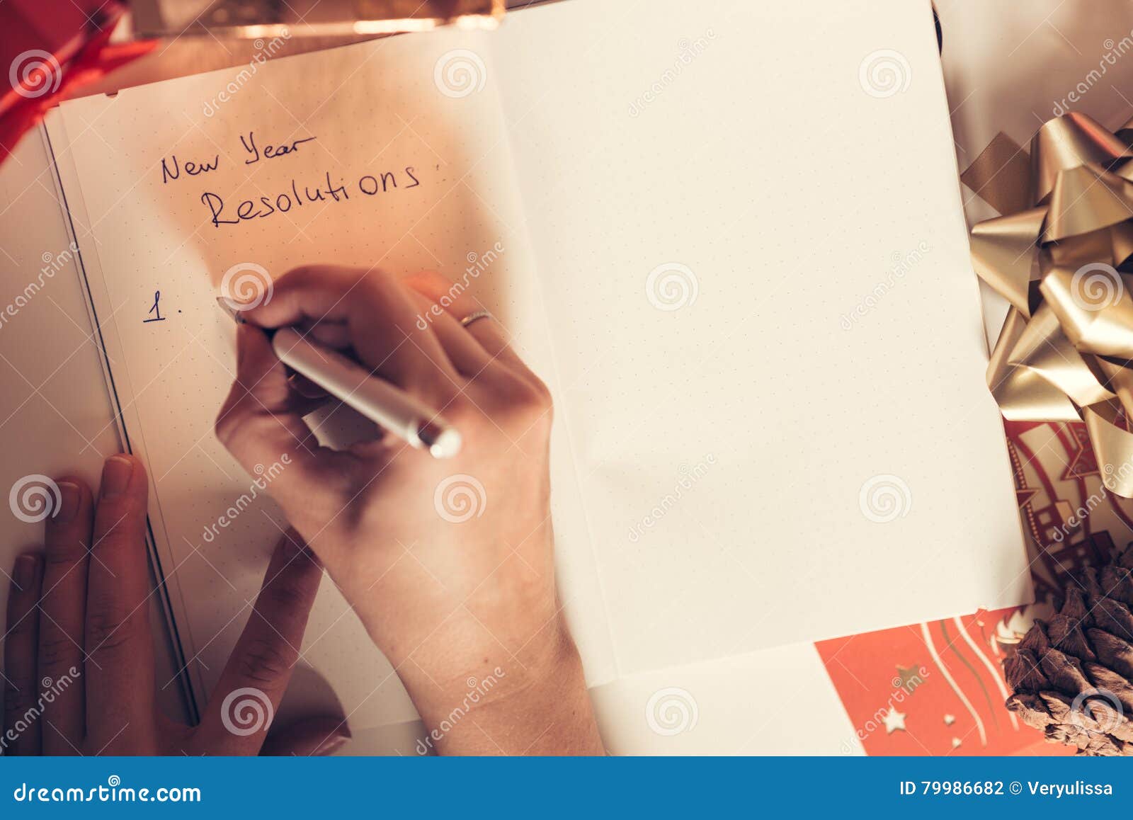 New Year Resolutions Written with a Hand on Notebook with New Ye Stock ...