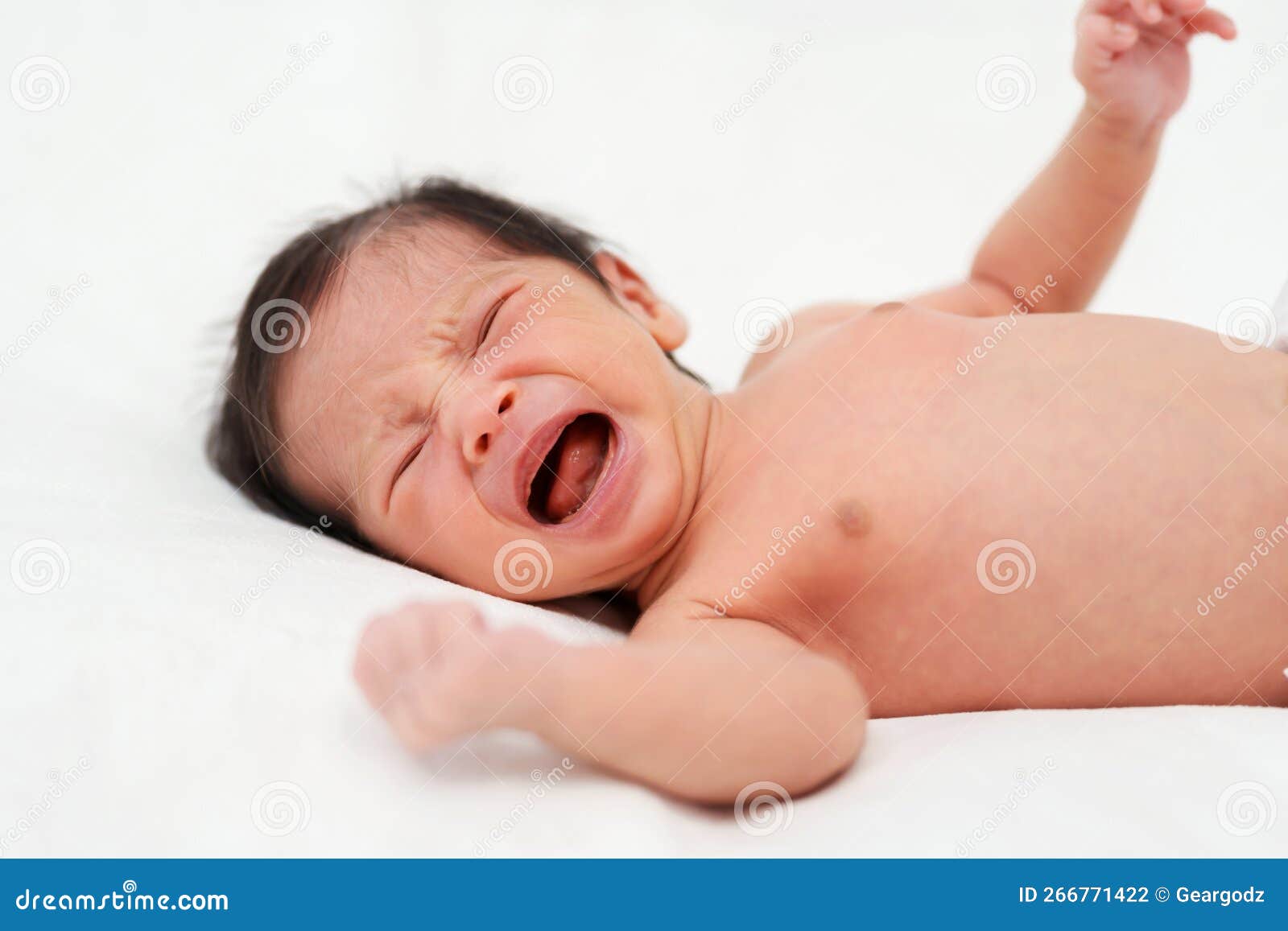 Newborn baby crying on bed stock photo. Image of crying - 266771422