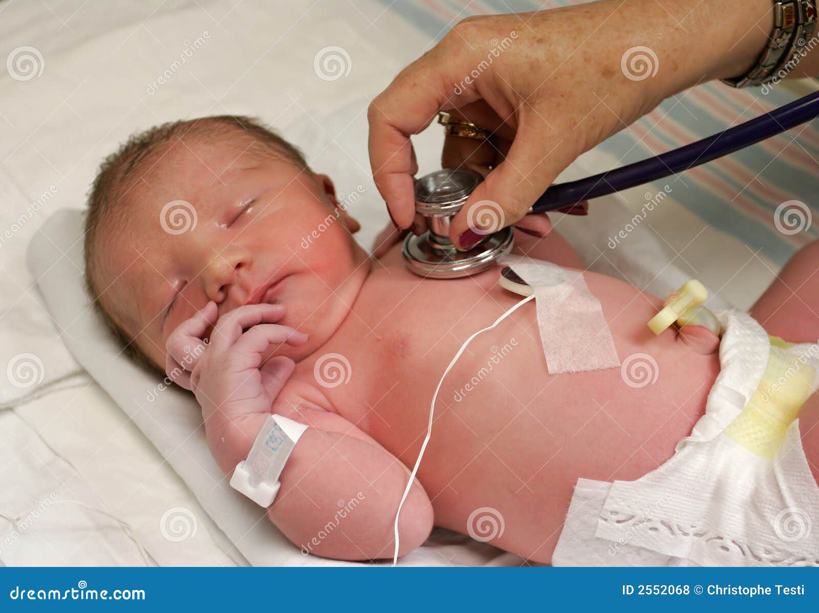 Newborn being checked stock photo. Image of beautiful - 2552068