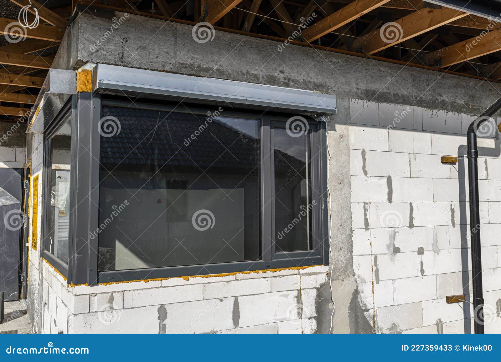 Newly Installed Corner Window with Roller Shutters in the House Under ...