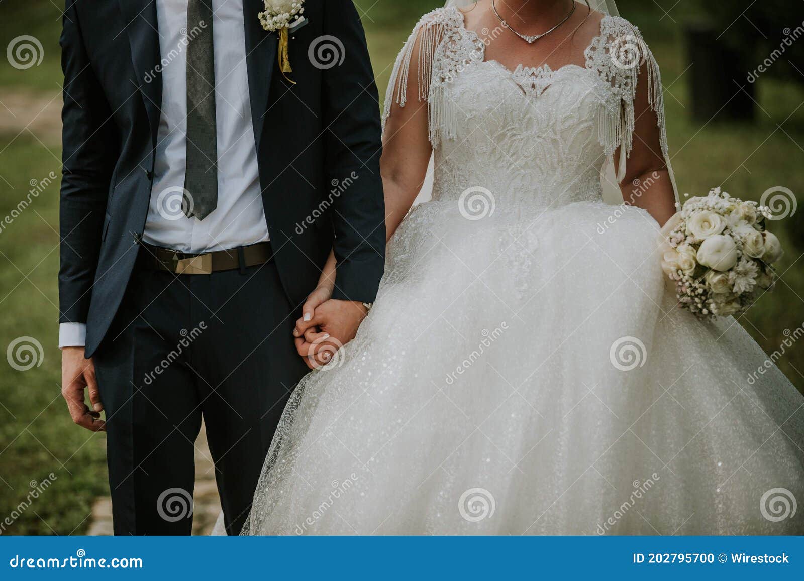Newlywed Couple Holding Hands Together while Walking Stock Photo ... Newlywed Couple Holding Hands Together while Walking Stock Photo ...