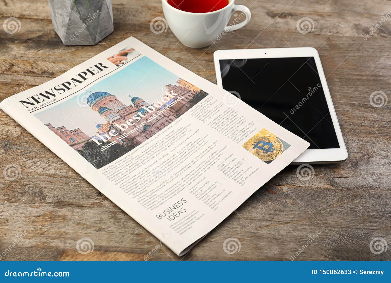 Newspaper with Cup of Tea and Tablet Computer on Table Stock Image ...