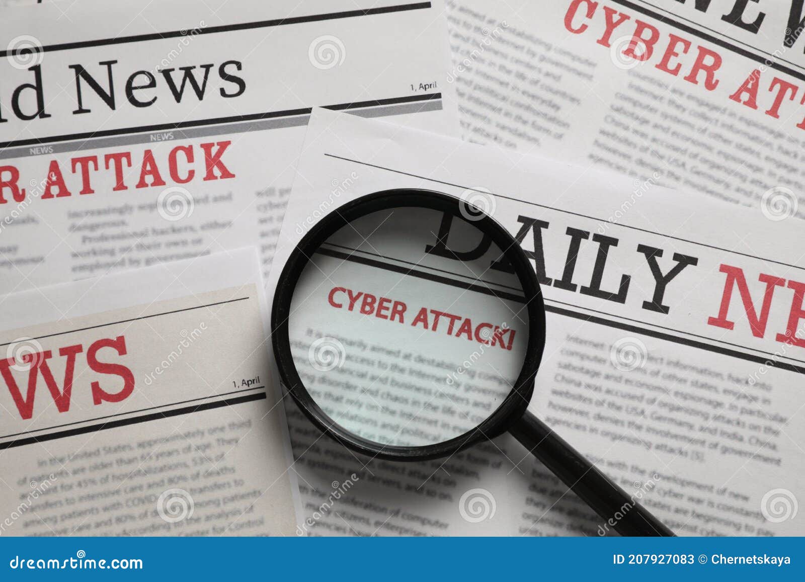 Newspaper with Headline CYBER ATTACK Under Magnifying Glass, Top View ...