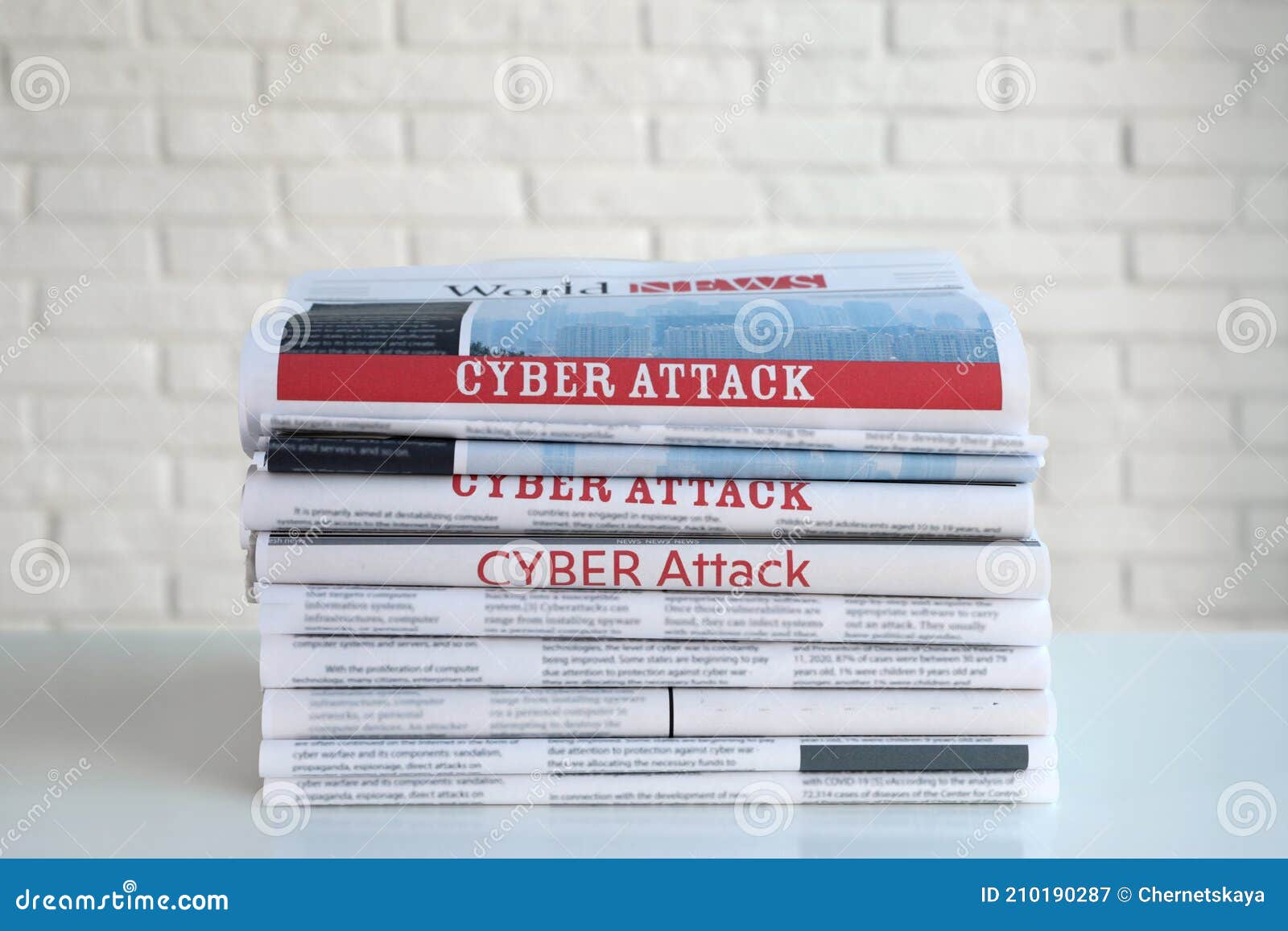 Newspapers with Headlines CYBER ATTACK Stacked on Table Near White ...