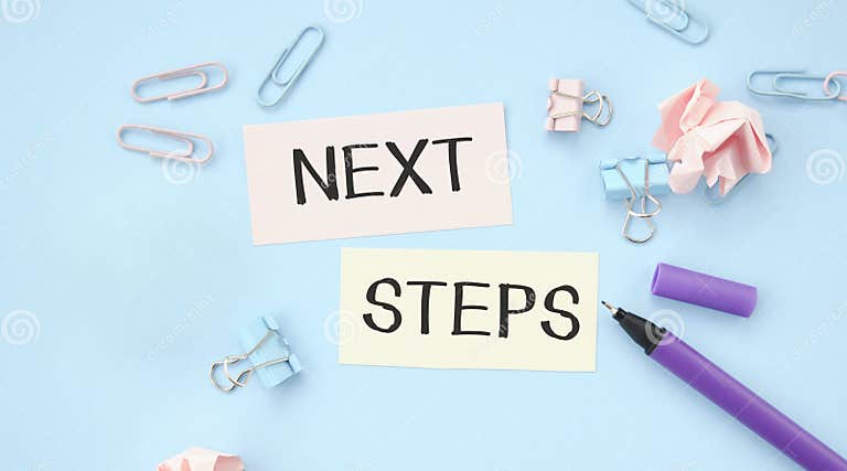 Next Steps Written on a Card Lying on the Blue Table and a Pen Stock ...