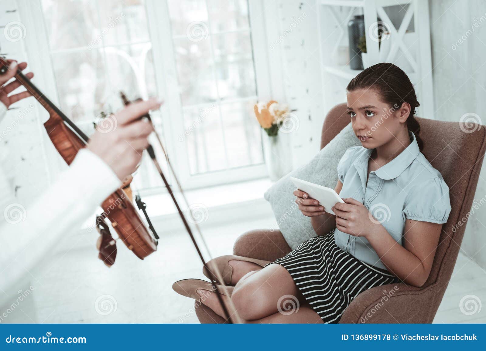 Nice Cheerless Girl Playing on Her Smartphone Stock Photo - Image of ...