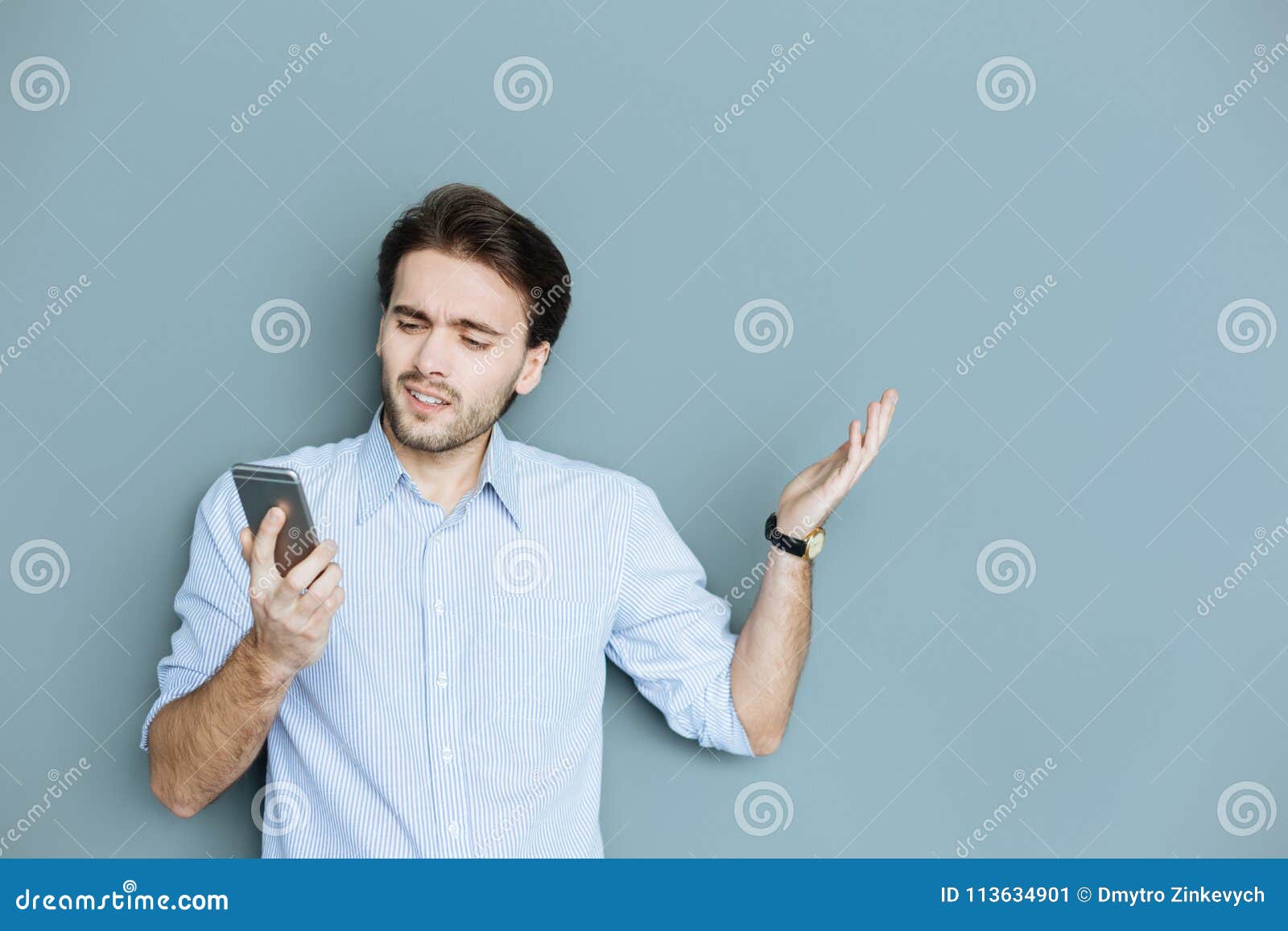 Nice Confused Man Looking at the Smartphone Screen Stock Image - Image ...
