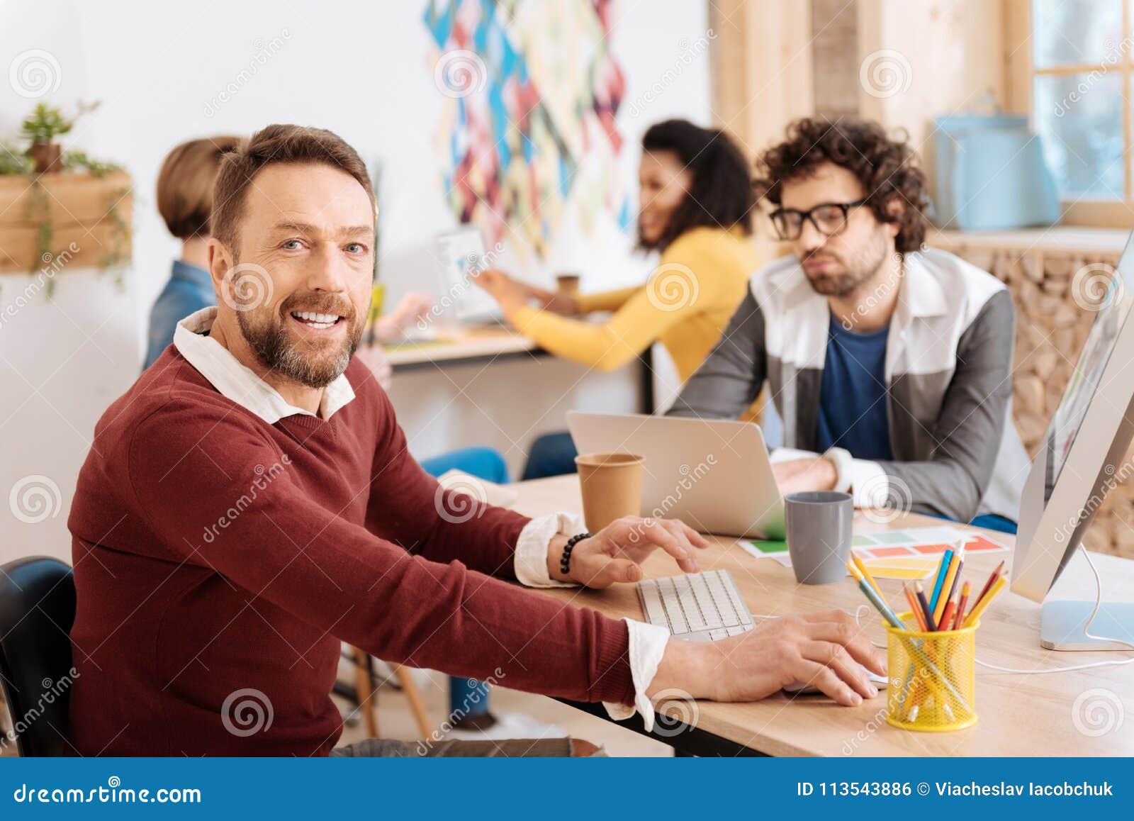 Smiling Man Working with His Colleagues in the Office Stock Photo ...