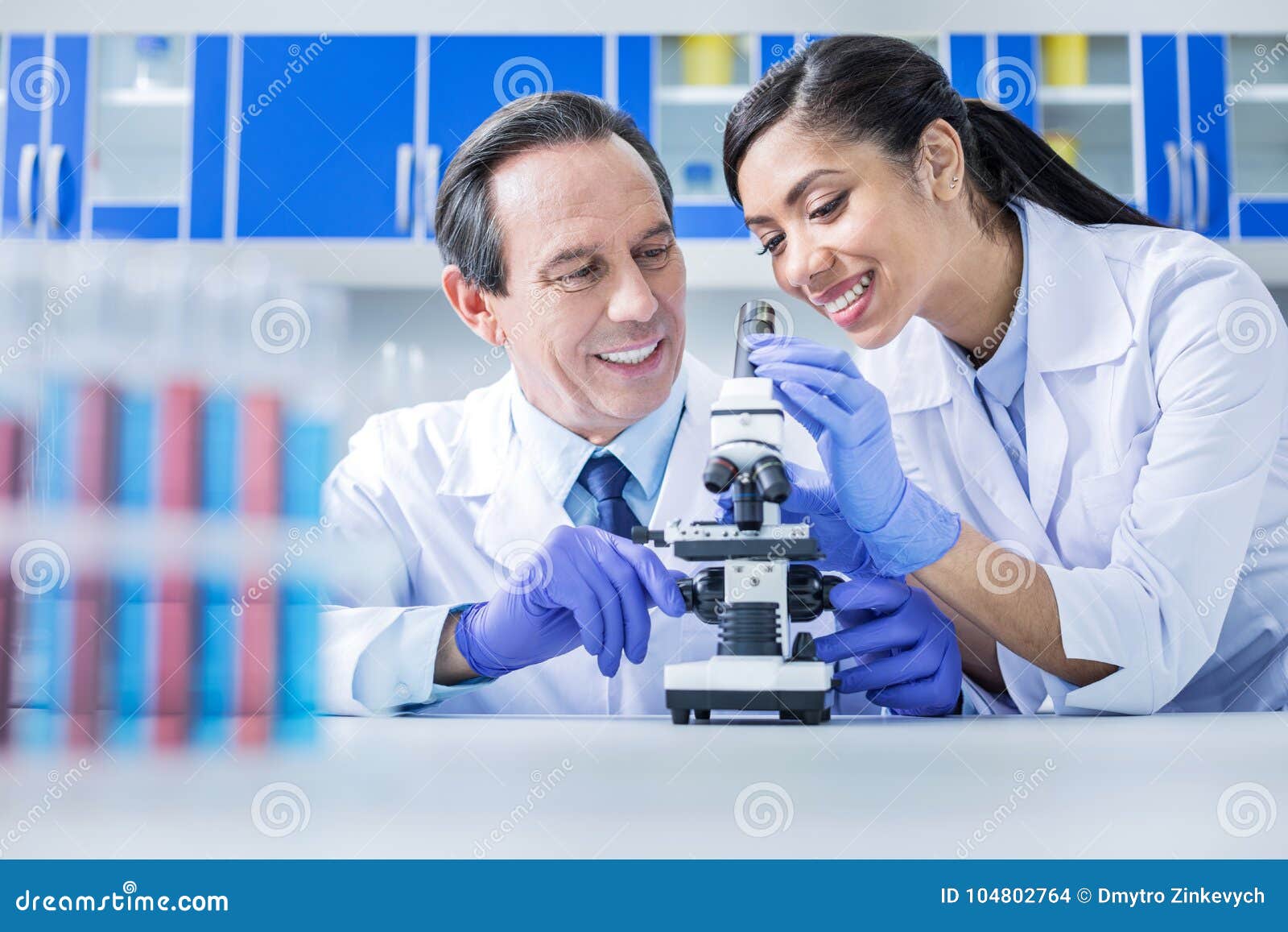Nice Delighted Biologists Working with Microscope Stock Photo - Image ...
