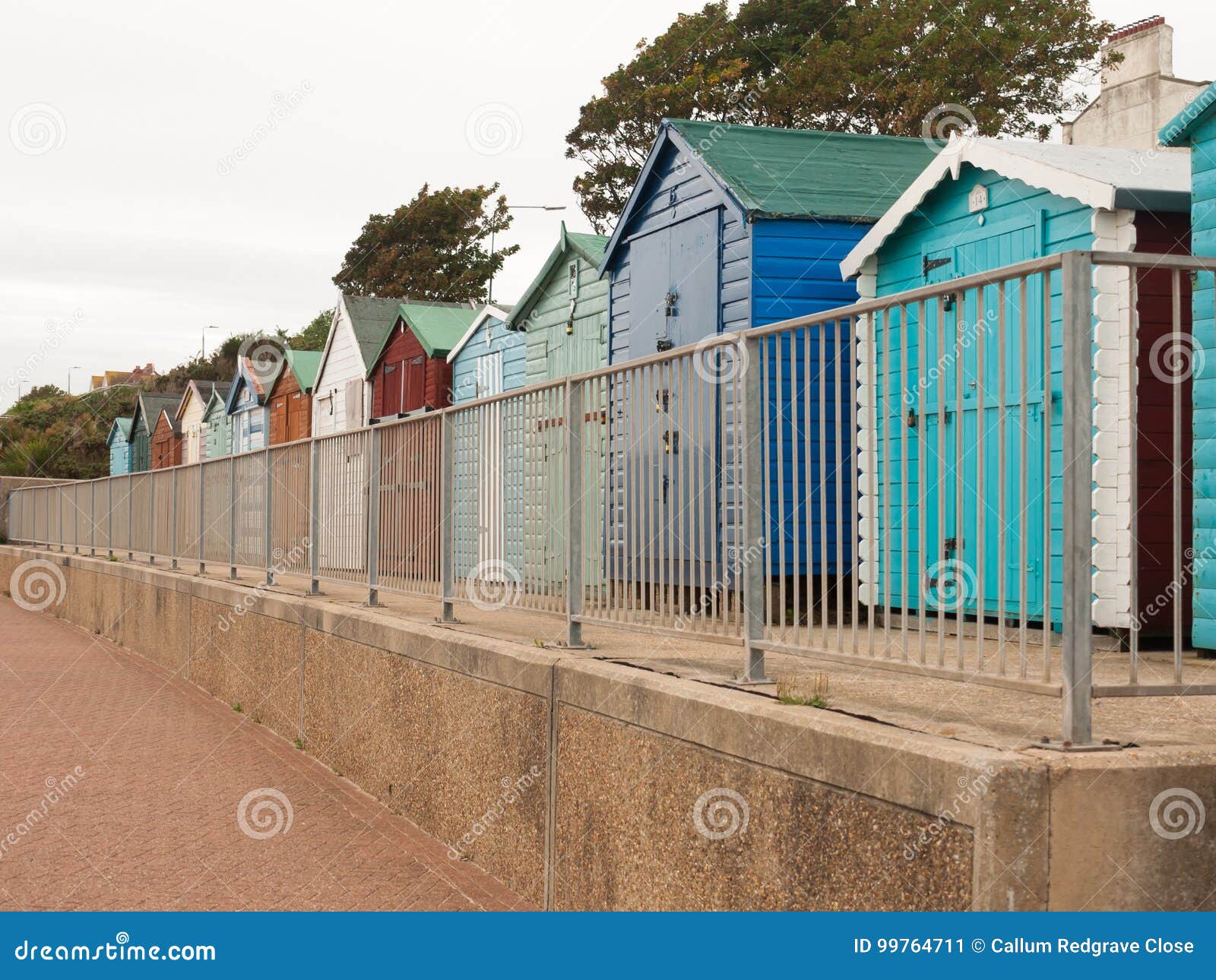 A Nice Even Row of Beach Huts with Fence in Front Down in Dovercourt ...