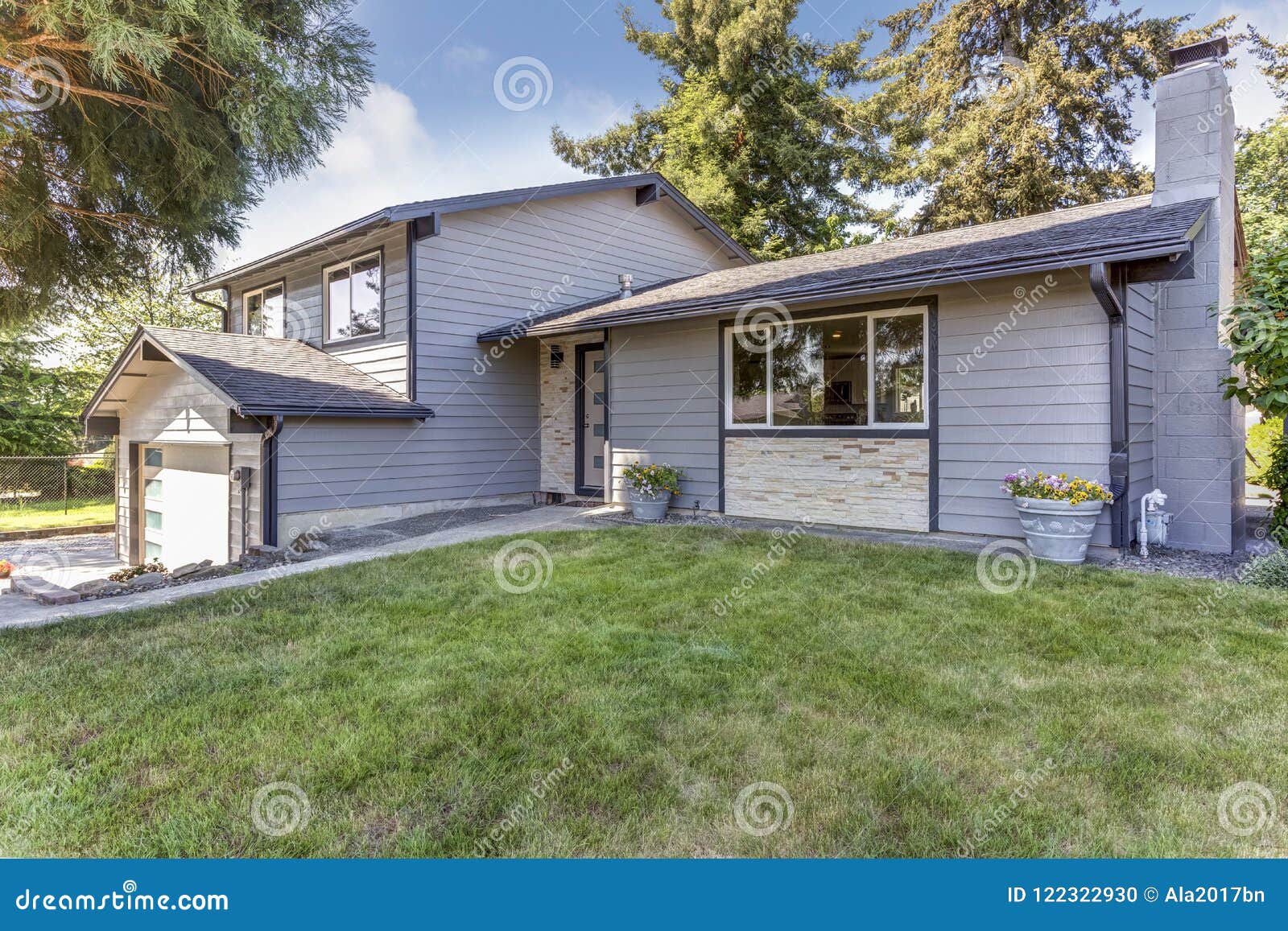 Nice Front View of Blue House Surrounded by Tall Trees. Stock Photo ...