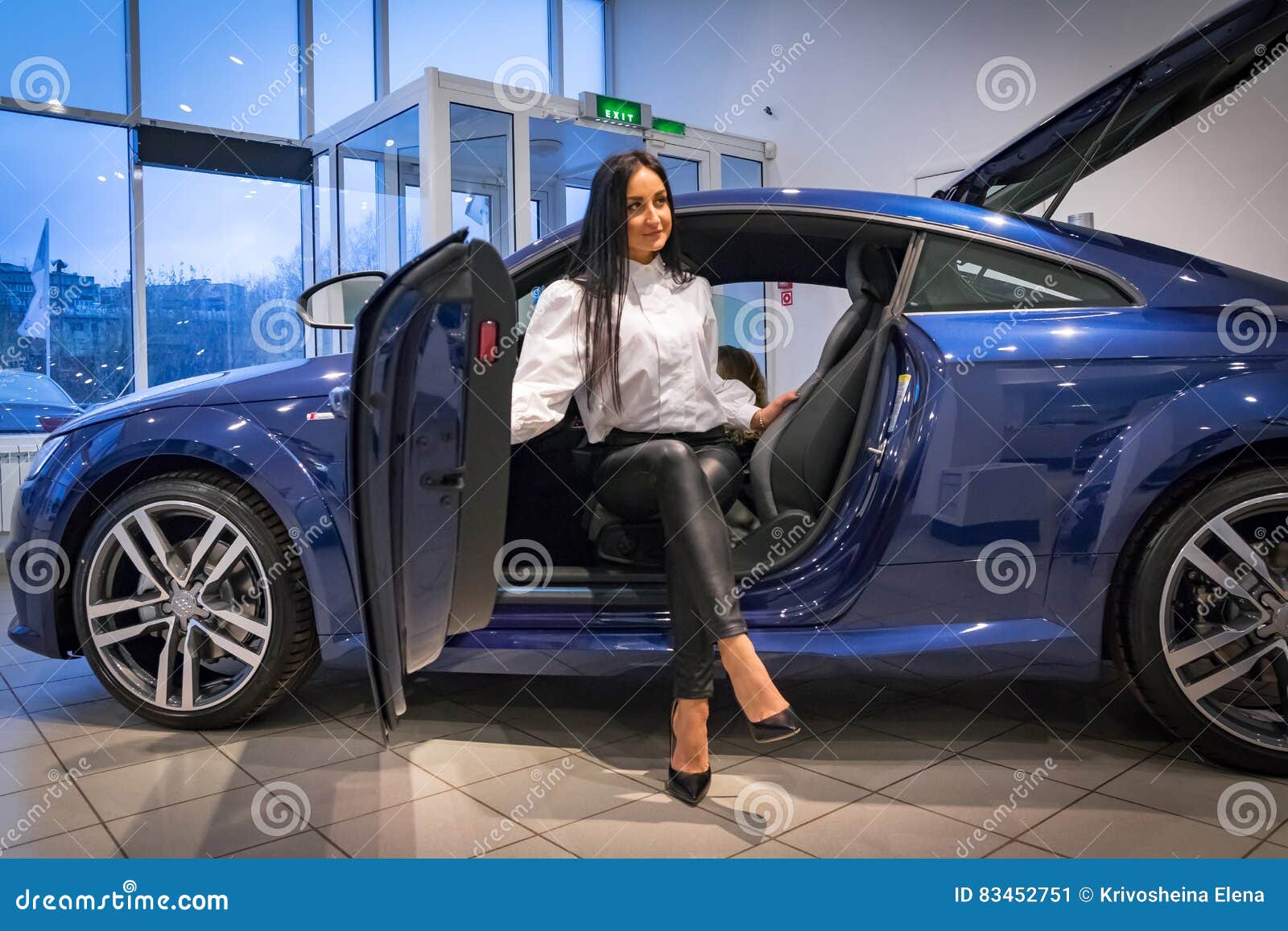 Nice girl in a car shop stock image. Image of buying - 83452751
