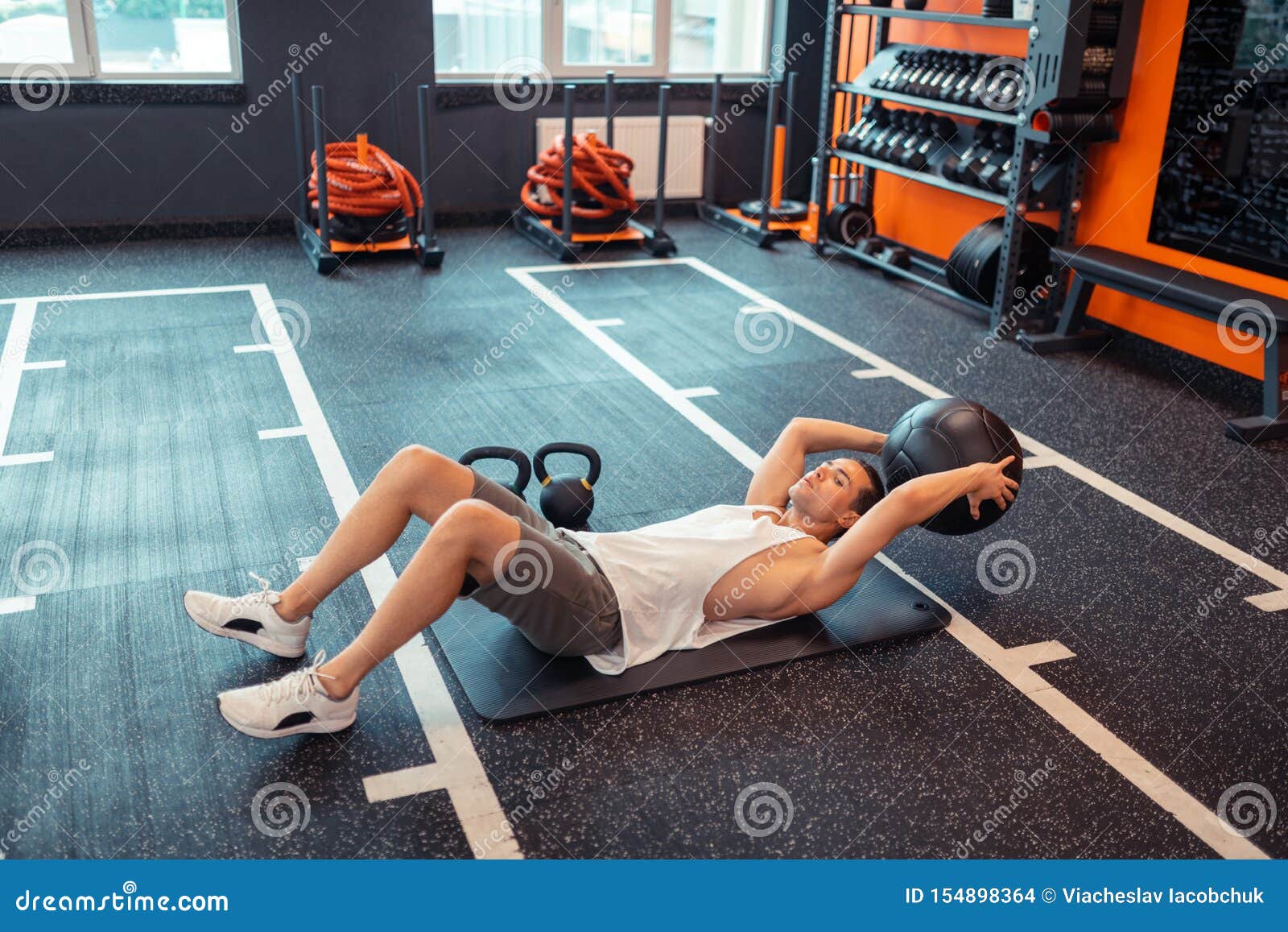 Nice Good Looking Man Lifting a Black Ball Stock Photo - Image of ...