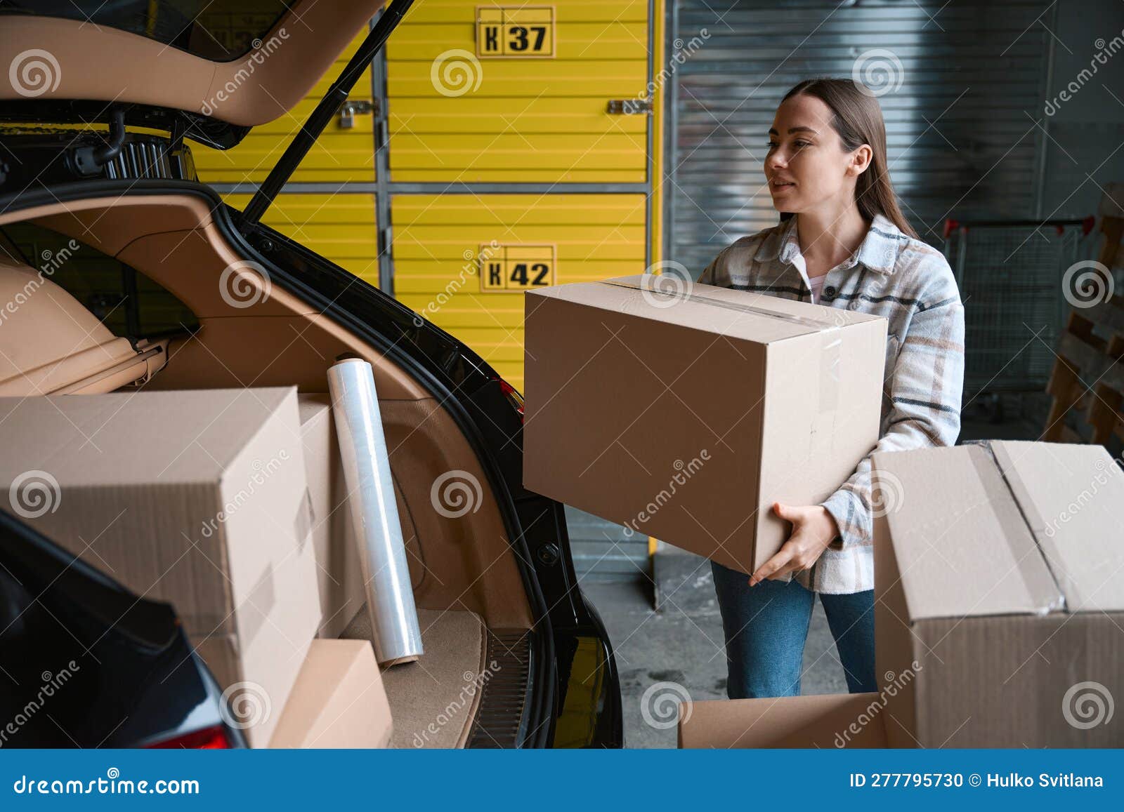 Nice Grown Woman Loading a Box into the Trunk Stock Photo - Image of ...