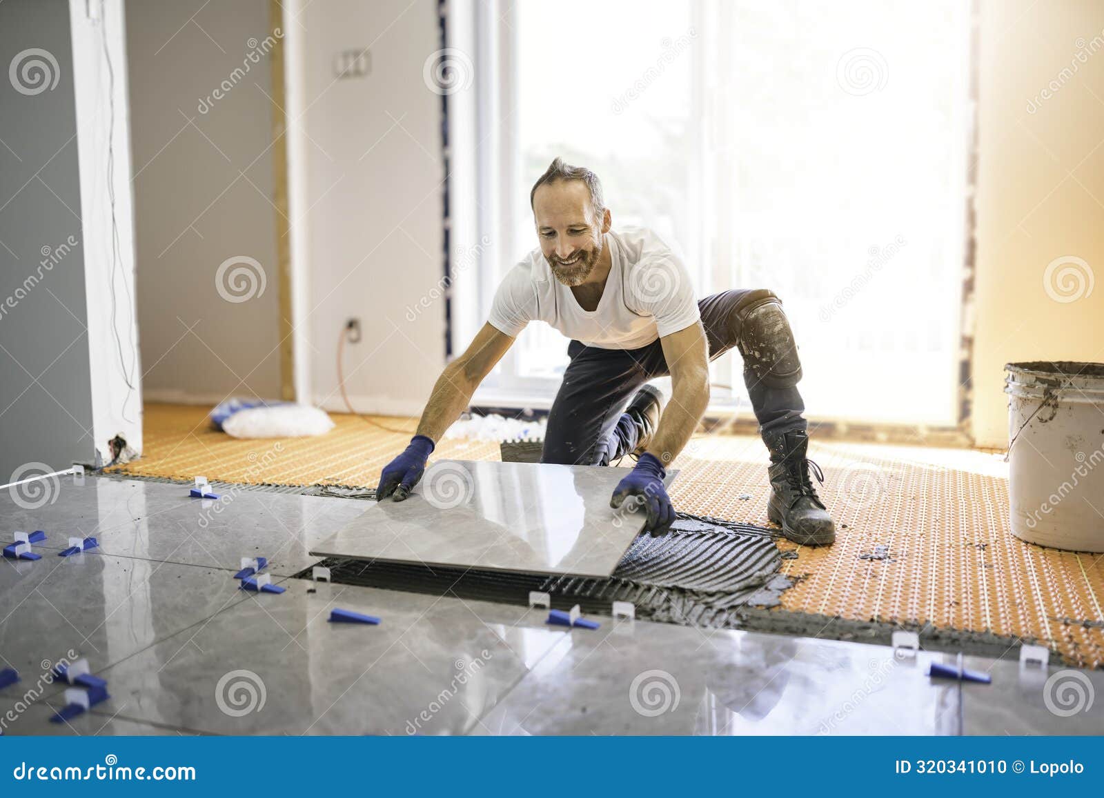 Nice Handyman Install Tile on the Floor Stock Photo - Image of ...