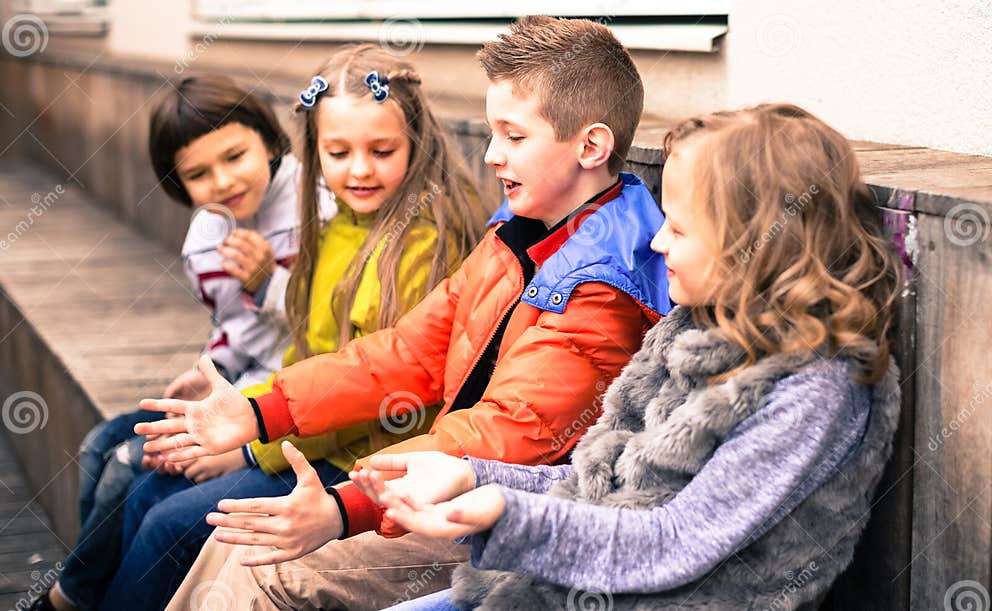 Nice Kids Talking on a Bench Stock Photo - Image of player, group ...