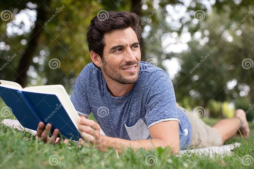 Looking man reading book stock image. Image of park - 319218079