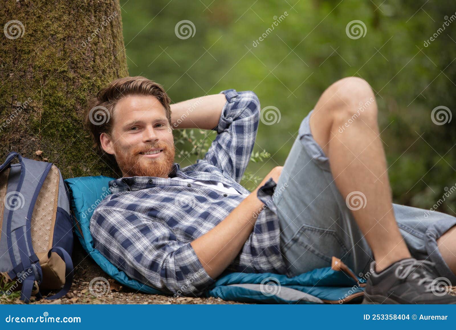 Nice-looking Man Sitting Against Tree in Grass Stock Photo - Image of ...
