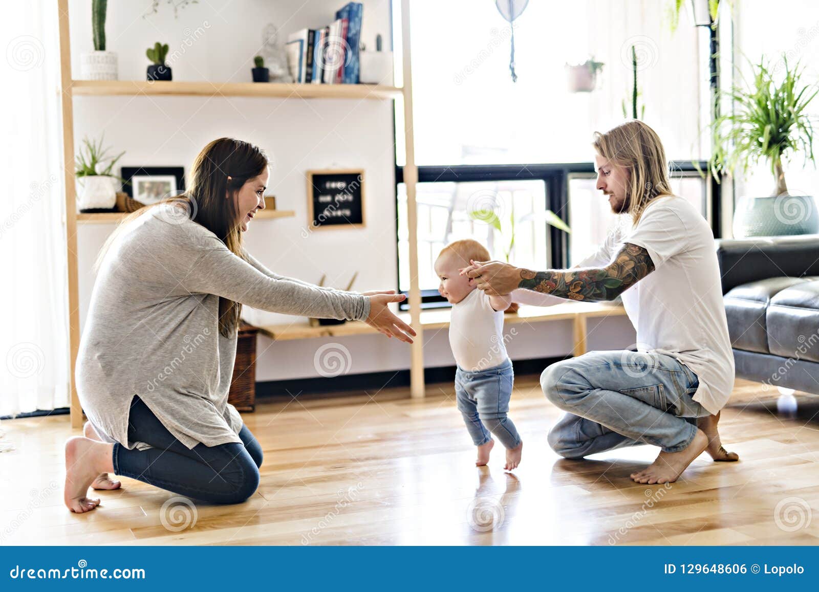 Parent Help Baby Daughter Take First Steps at Home Stock Photo - Image ...