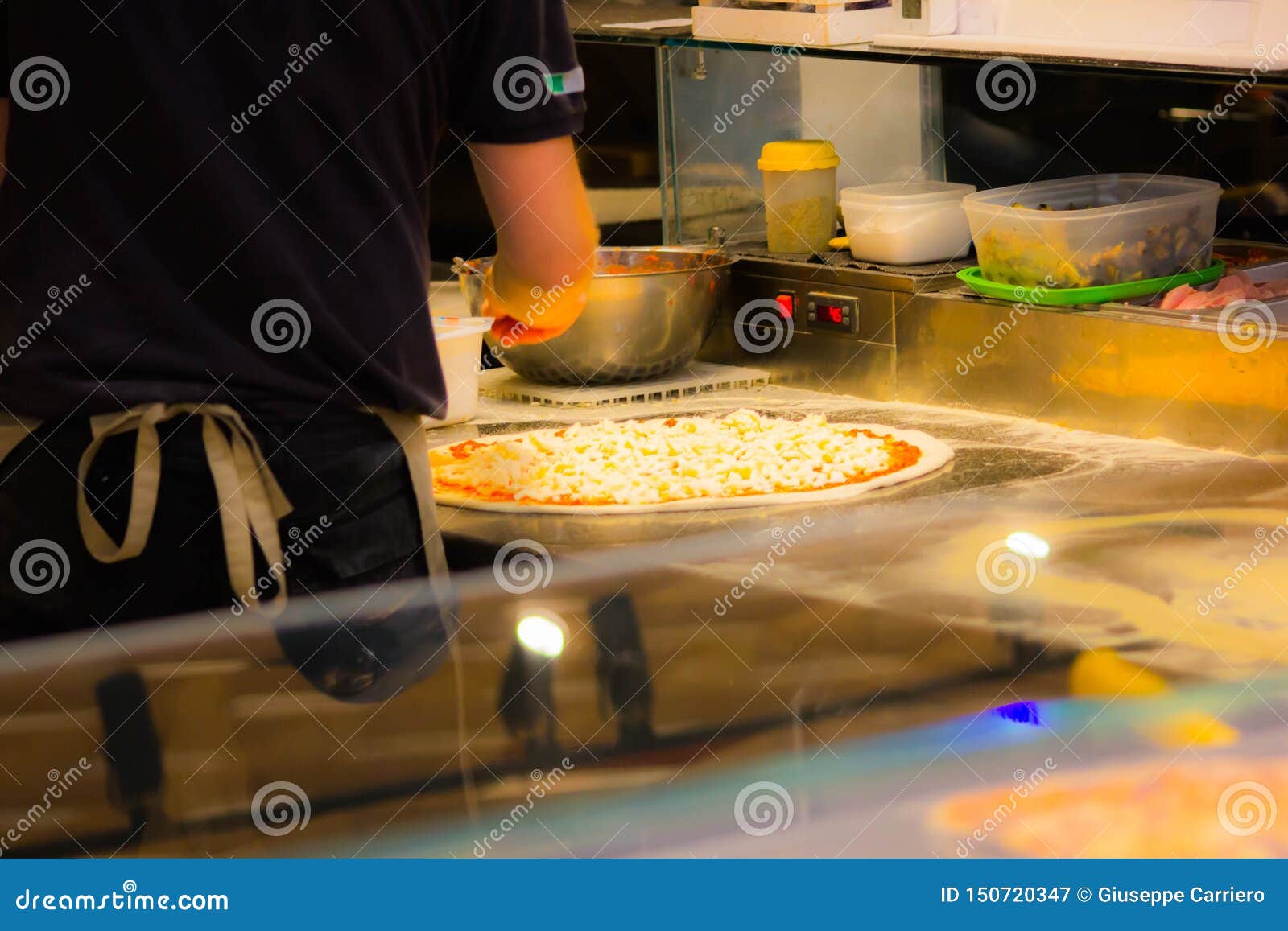 A Nice Pizza Maker while Working with the Oven Inserting One of His ...