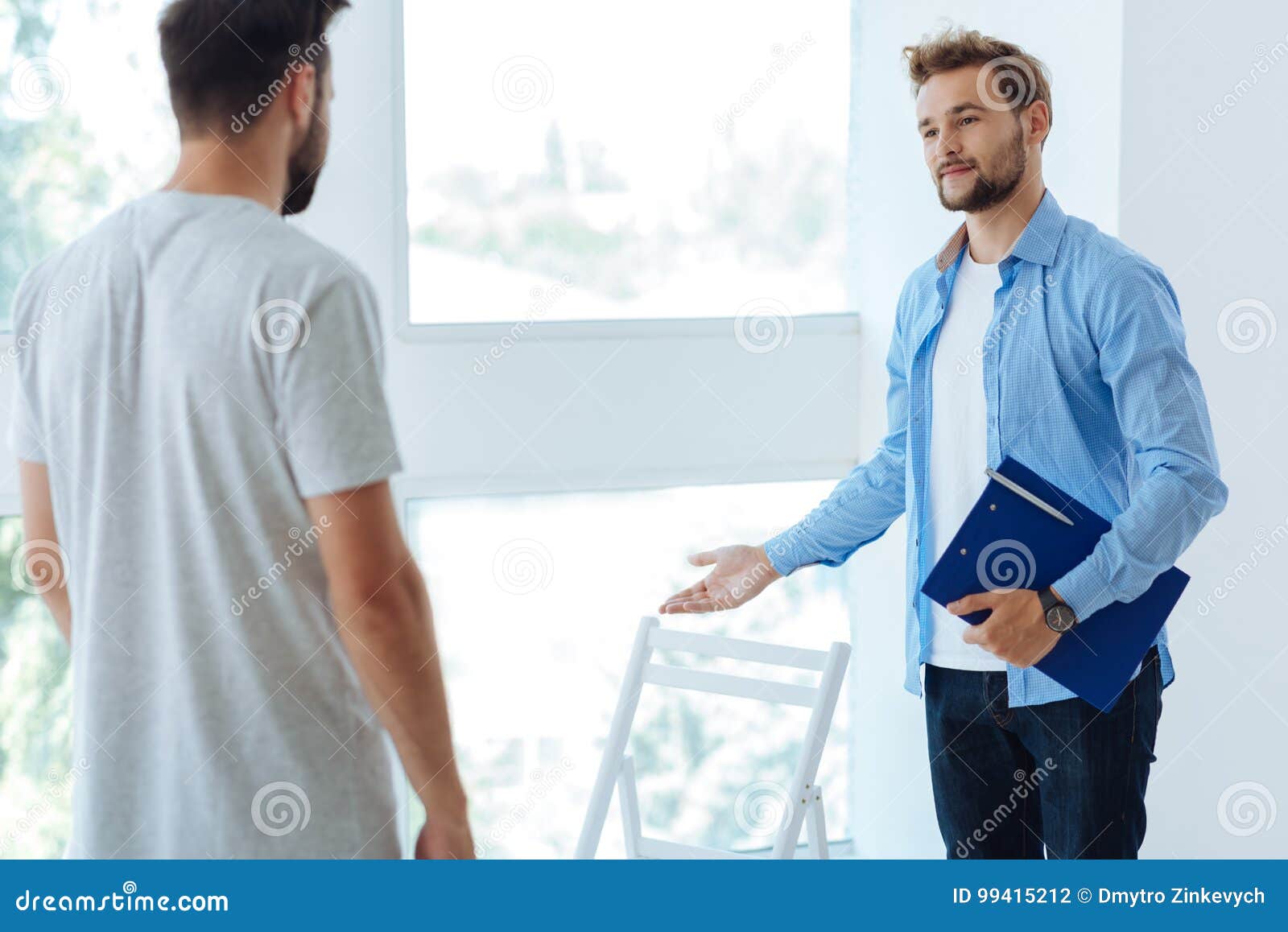 Nice Pleasant Therapist Looking at His Patient Stock Photo - Image of ...