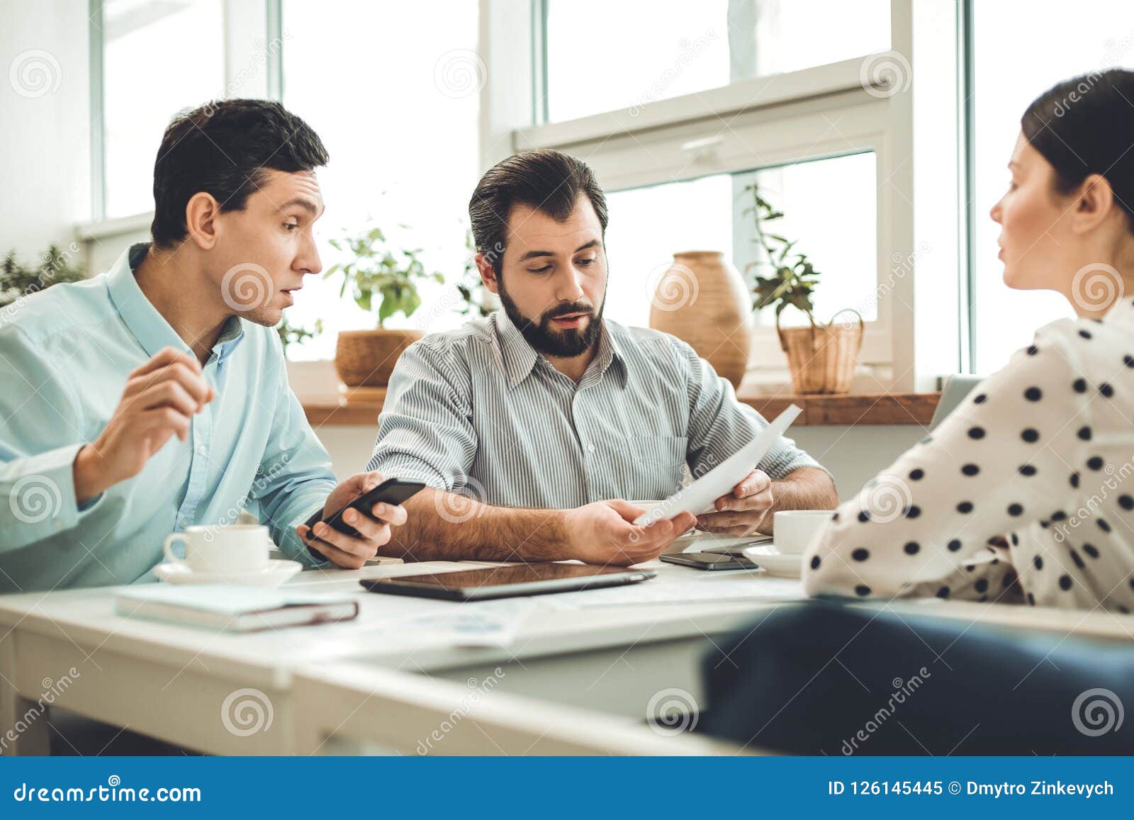 Nice Serious Young People Discussing Their Work Stock Image - Image of ...