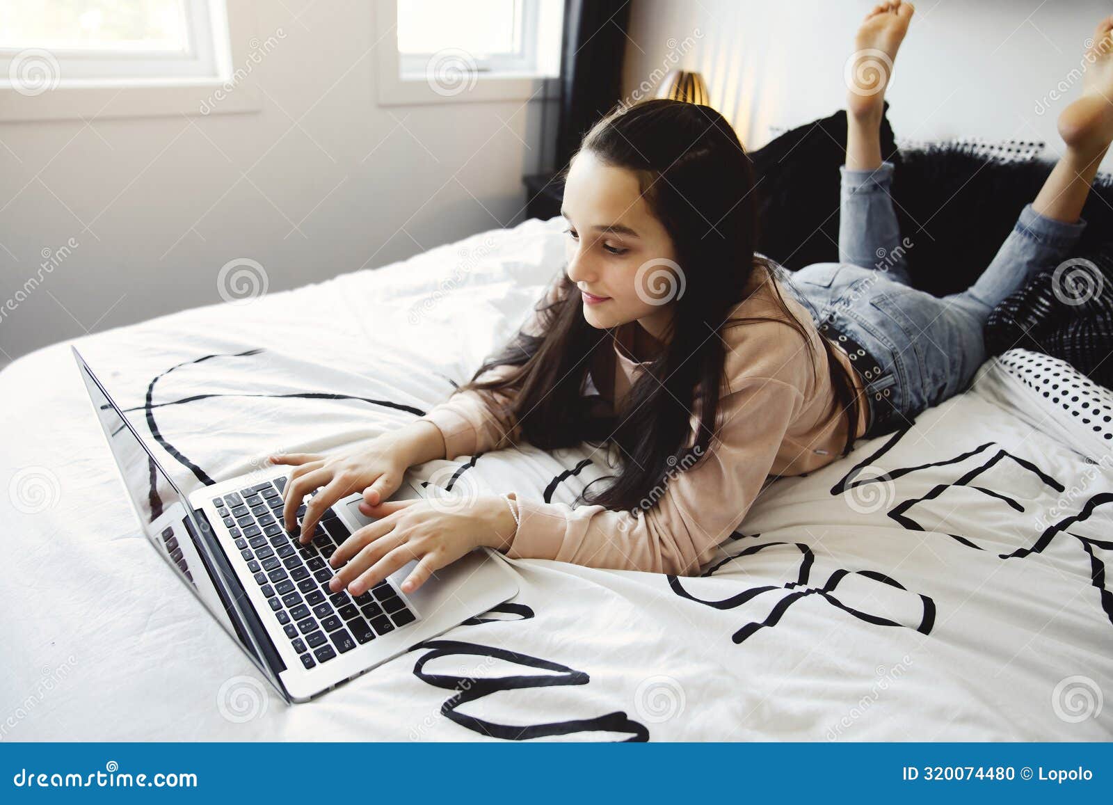 Nice Teenage Girl Using a Computer in Her Bedroom. Stock Photo - Image ...