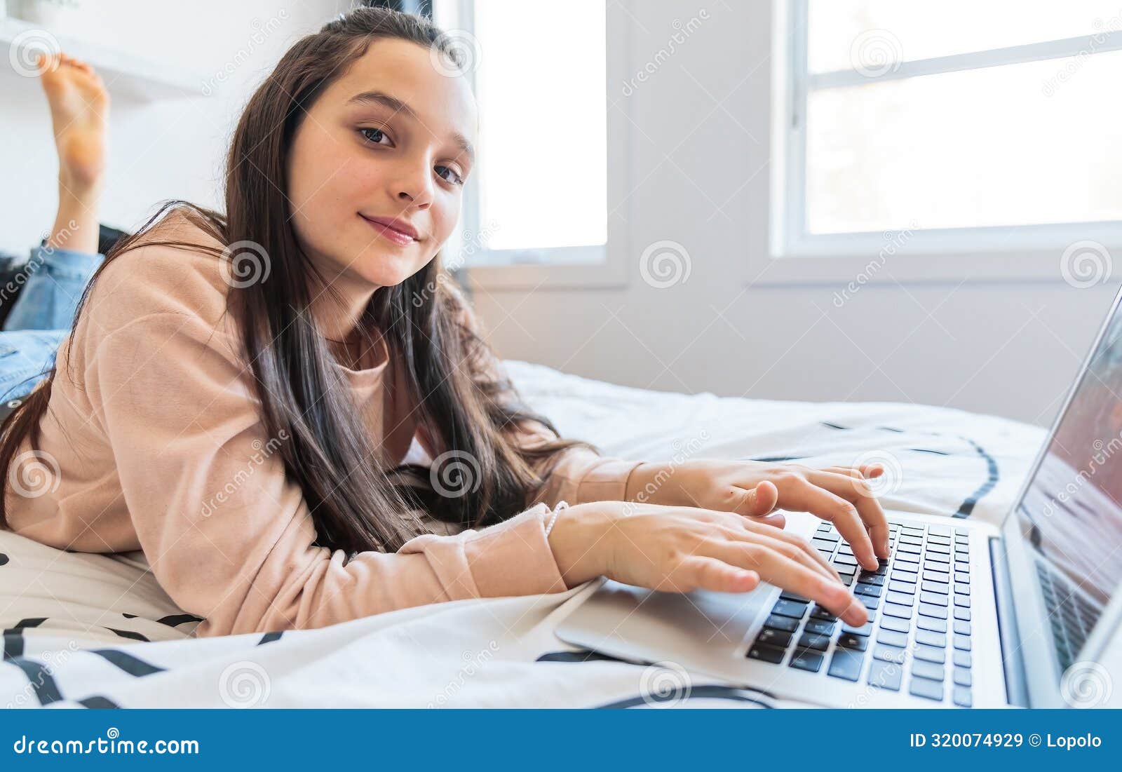 Nice Teenage Girl Using a Computer in Her Bedroom. Stock Image - Image ...