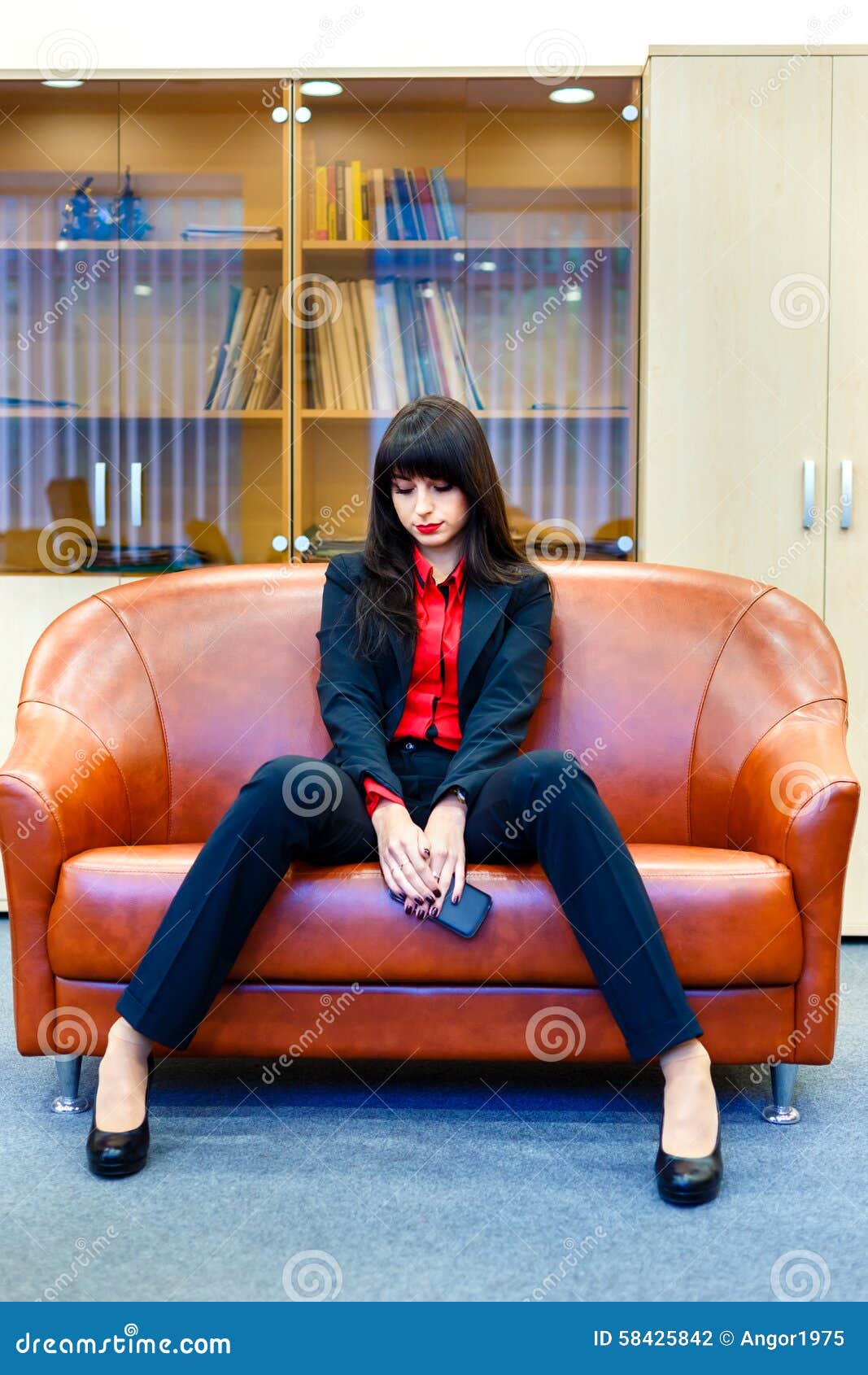 Nice Thoughtful Businesswoman in Suit Sitting in an Office on Stock ...