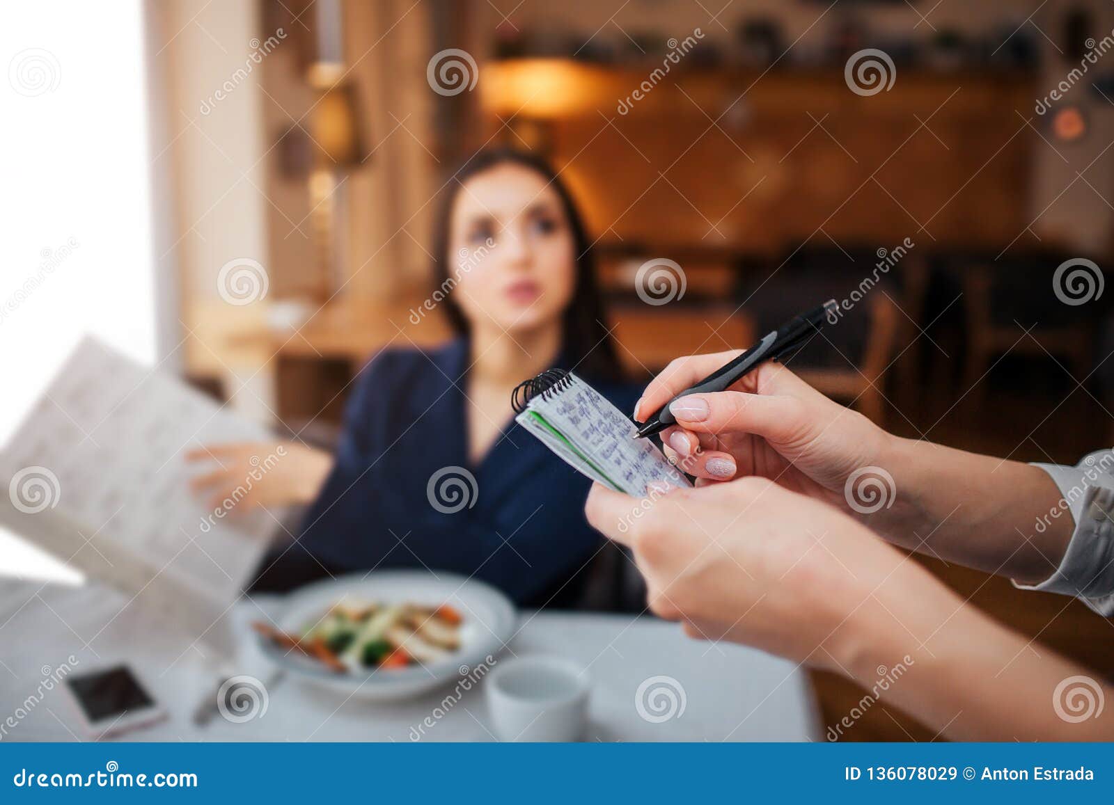 Nice Young Buisnesswoman Sit at Table in Restaurant. she Point on Menu ...