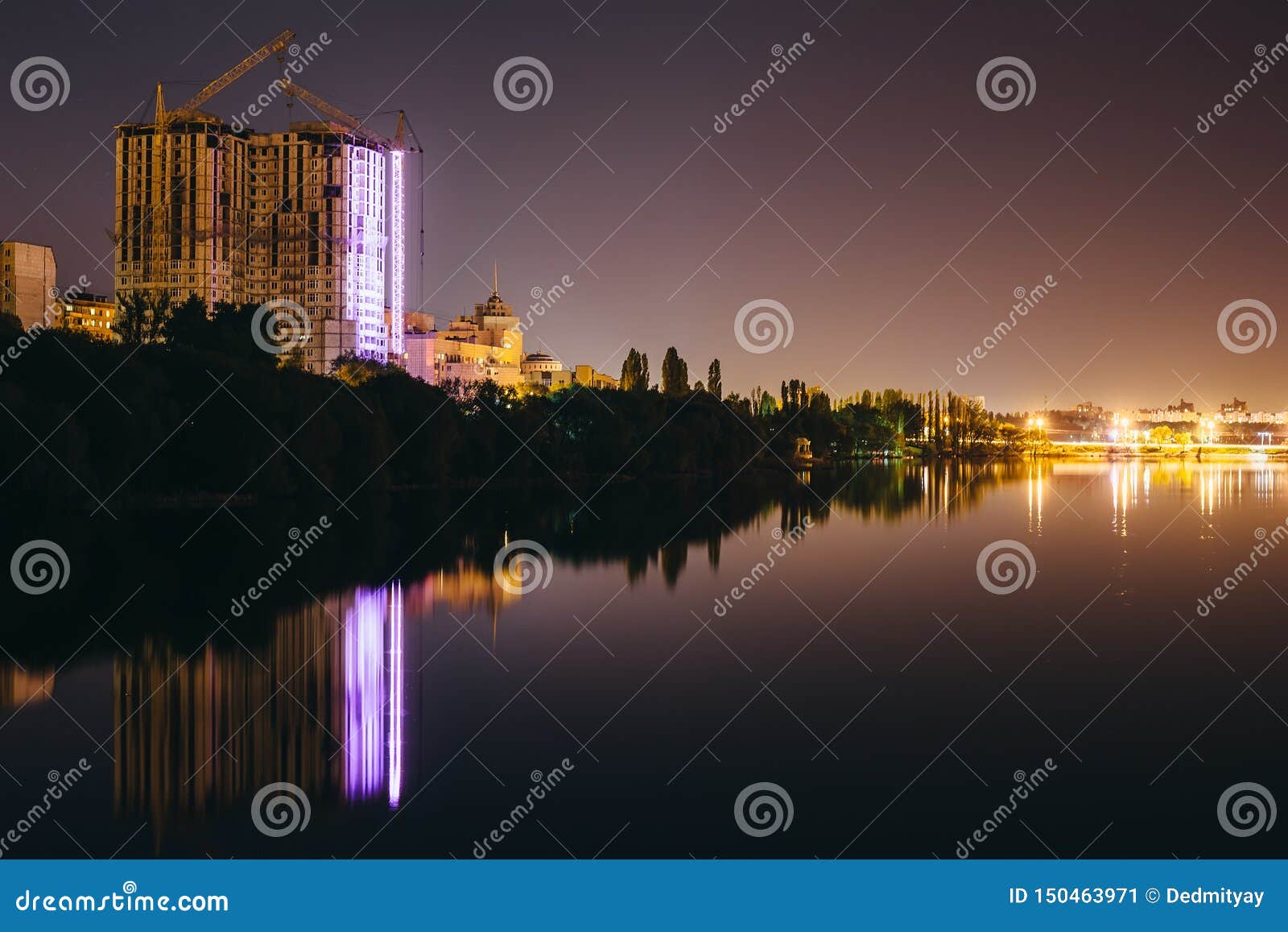 Night City with Reflection of Road and Illuminated Building Lights in ...